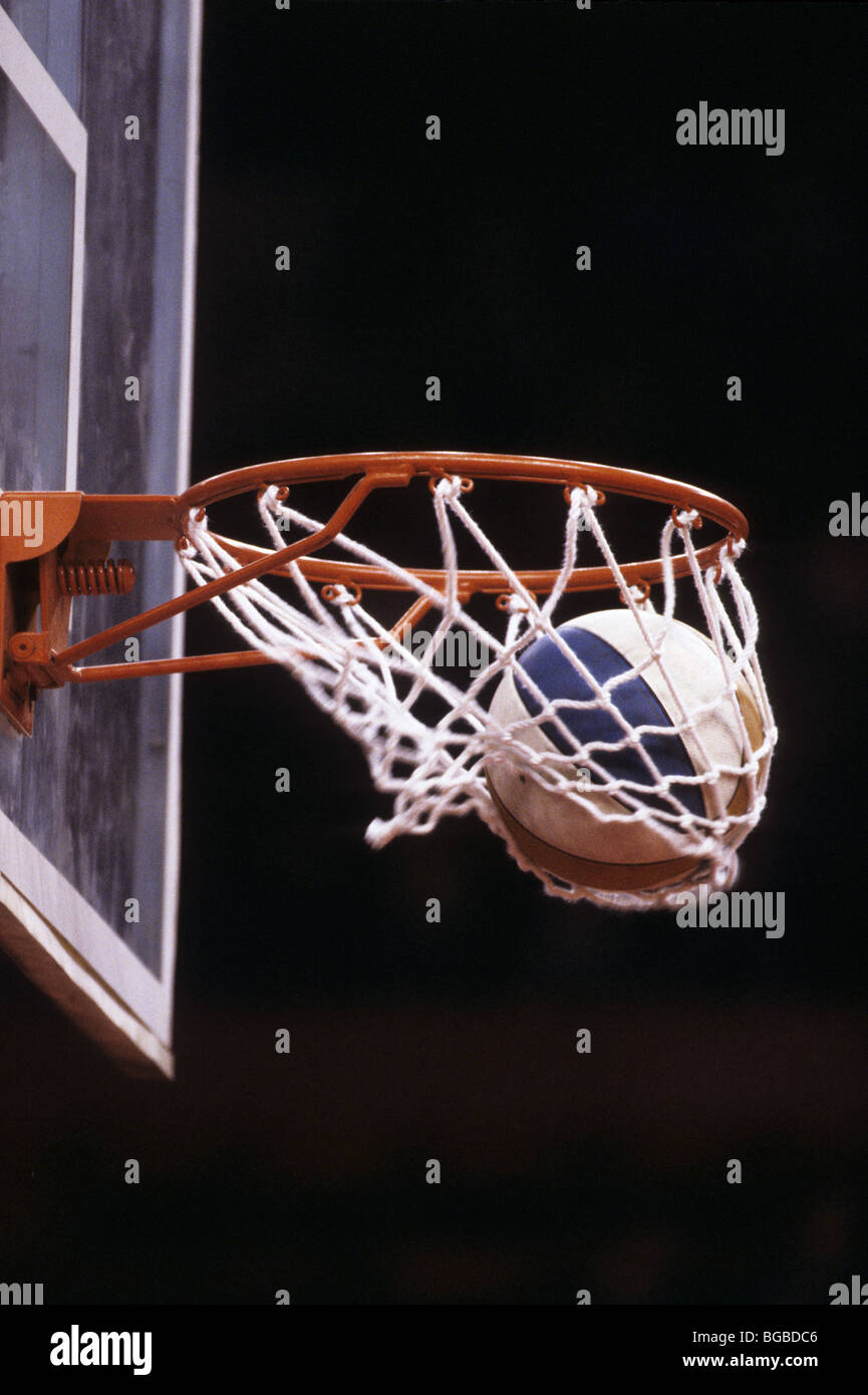 Basketball going through a hoop Stock Photo - Alamy