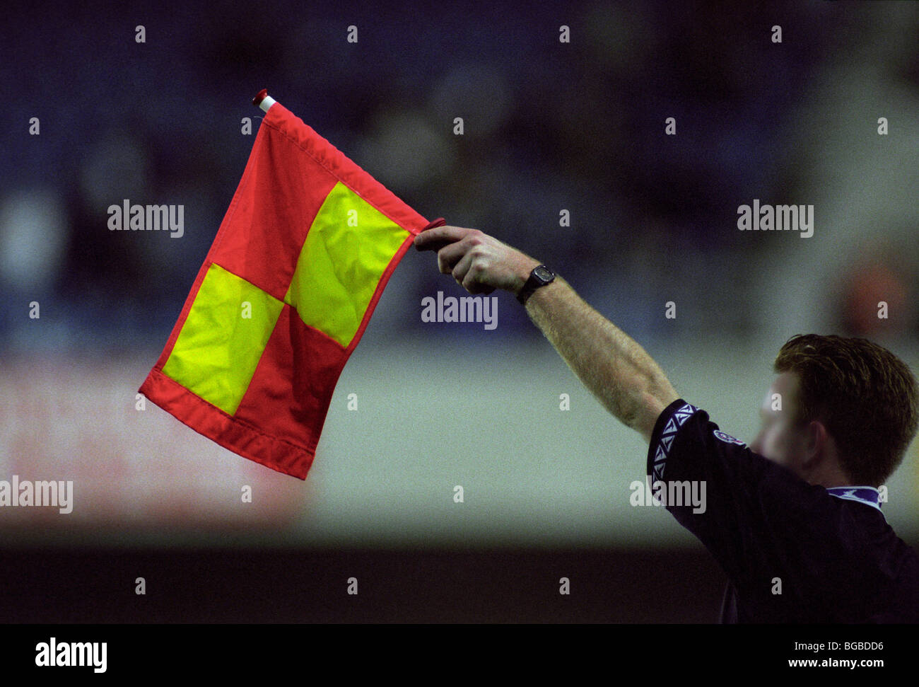 Football referee holding up his flag Stock Photo - Alamy