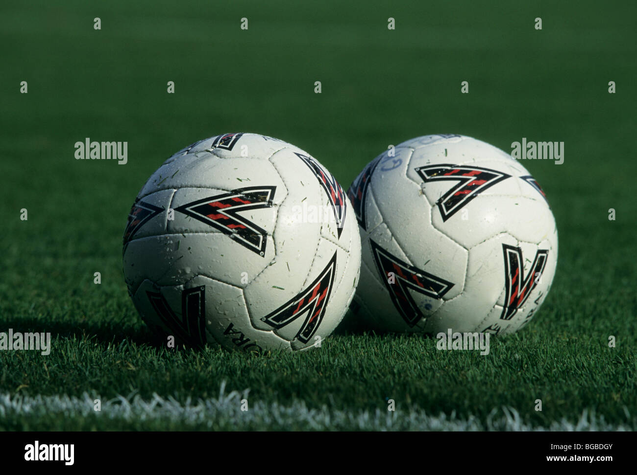Two footballs on a pitch Stock Photo - Alamy