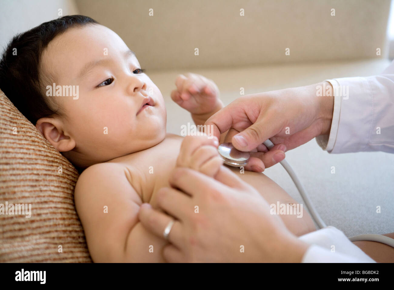 Infant receiving medical check-up Stock Photo - Alamy