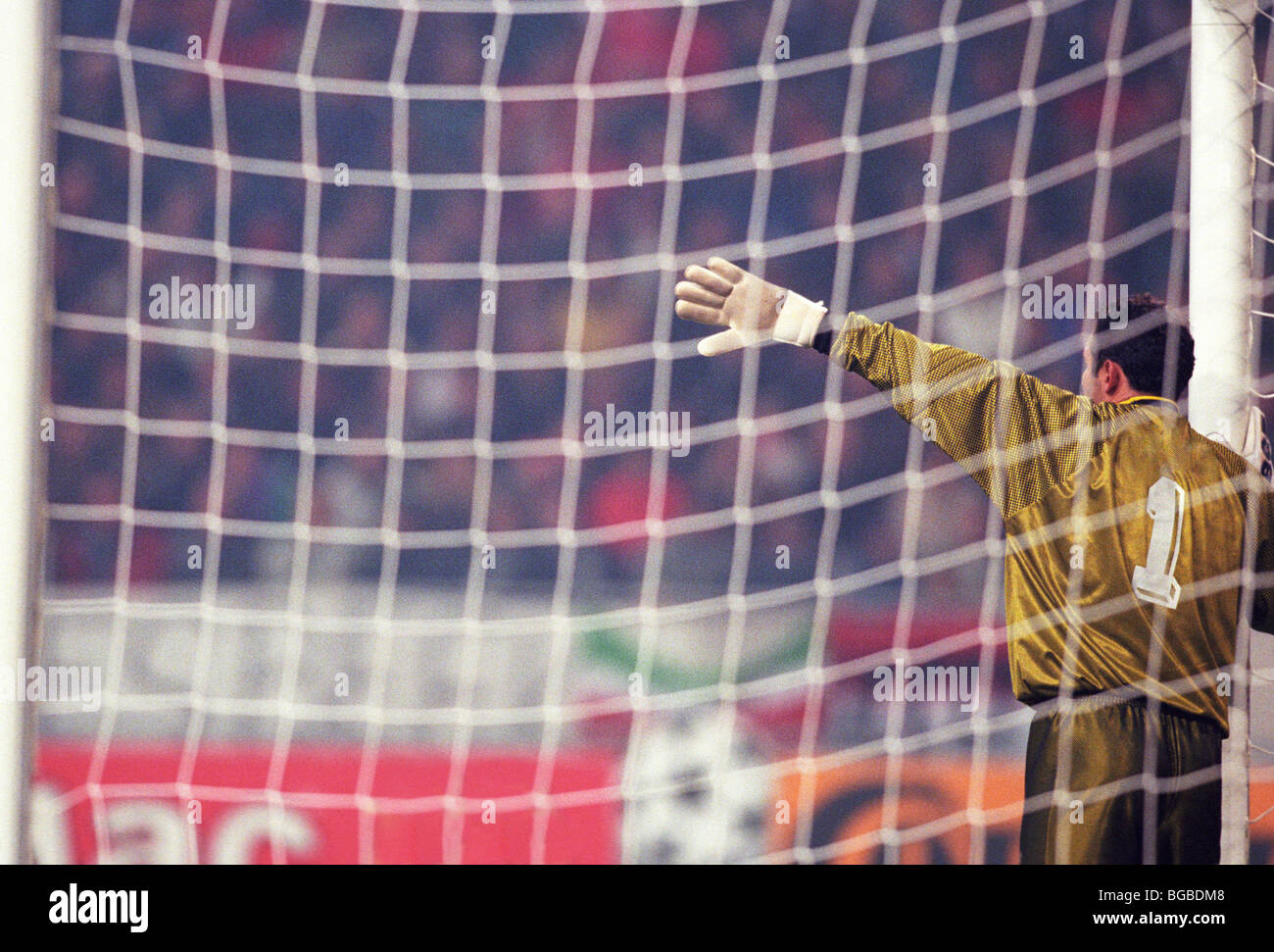 Goalkeeper in the goal directing the wall formation for a free kick ...