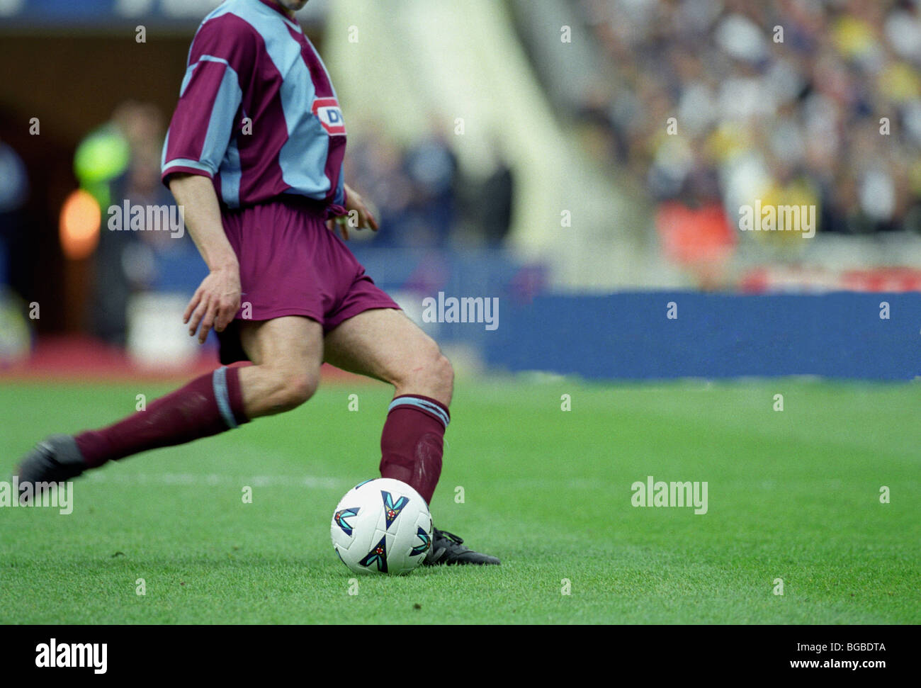 Football player kicking the ball Stock Photo - Alamy