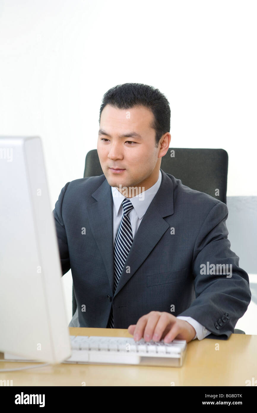 Man uses computer in a well-lit, sunny office Stock Photo - Alamy