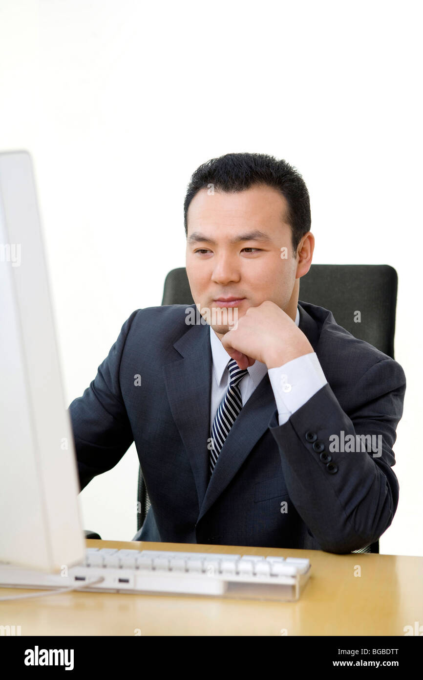 Man uses computer in a well-lit, sunny office Stock Photo - Alamy