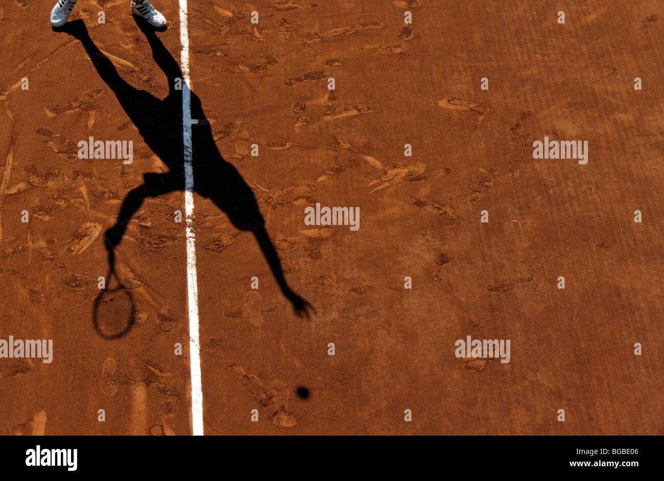 Shadow of a tennis player on a clay court Stock Photo - Alamy