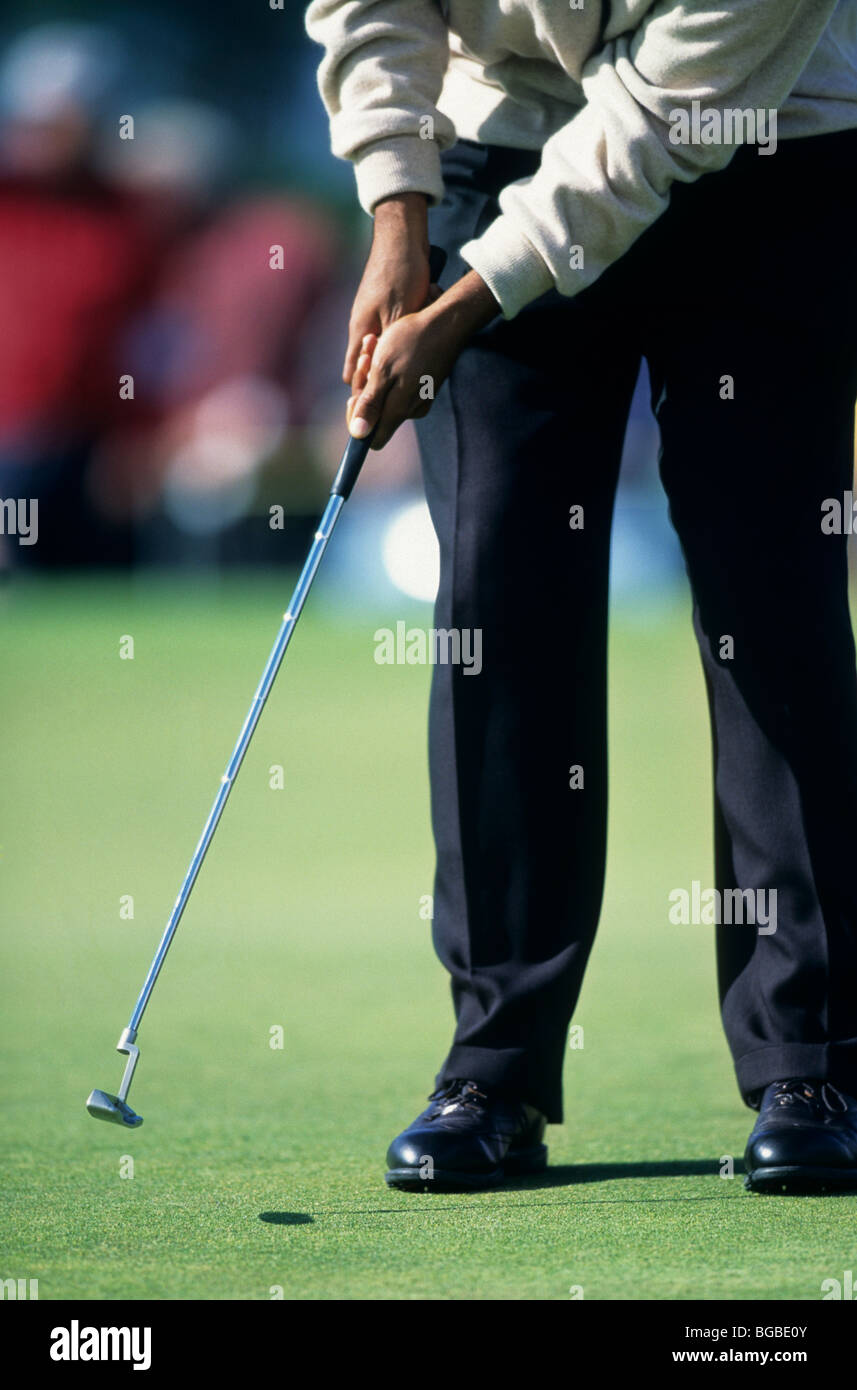 Golfer with a putter club Stock Photo - Alamy