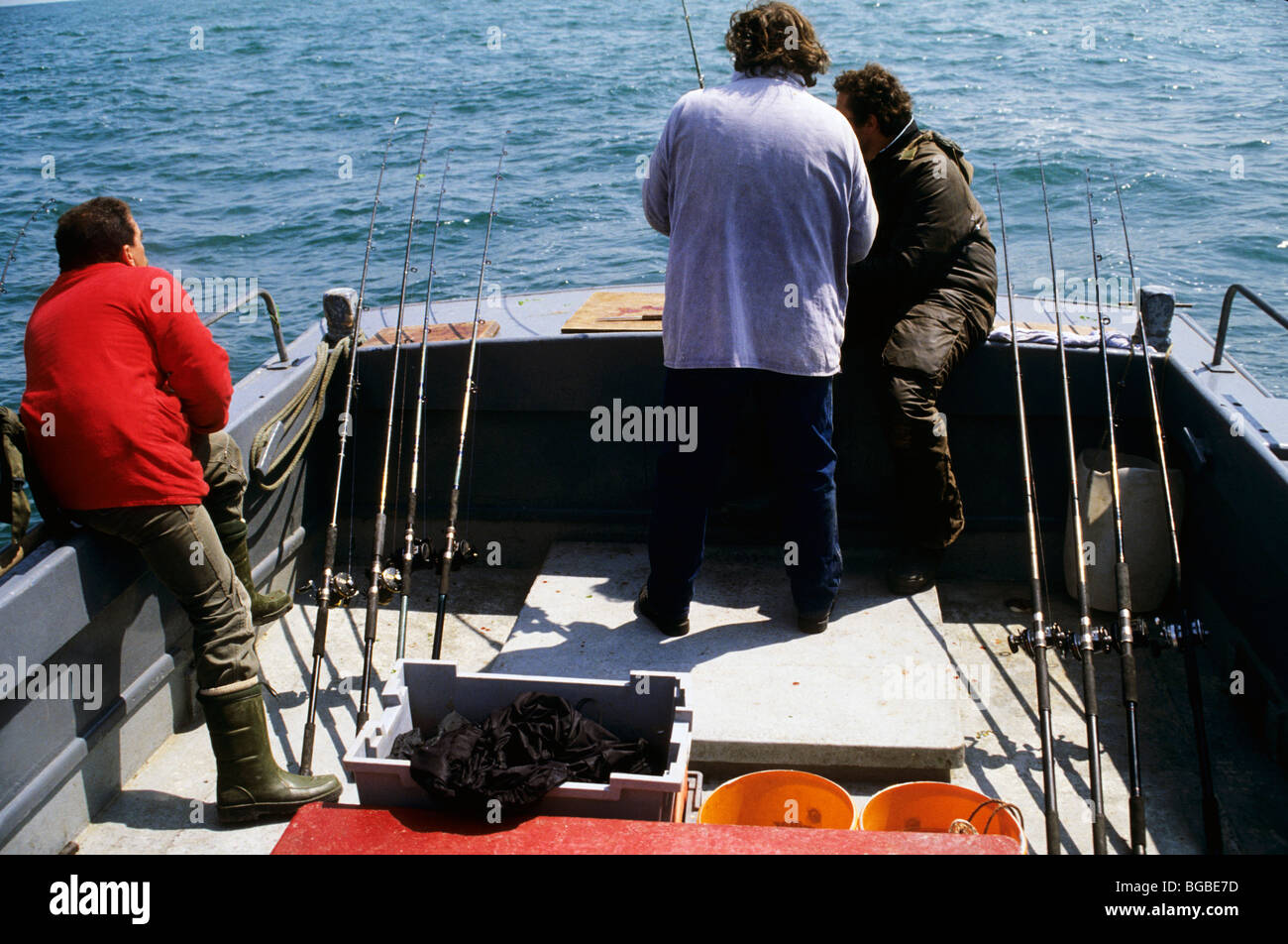 Three fishermen on a boat Stock Photo - Alamy