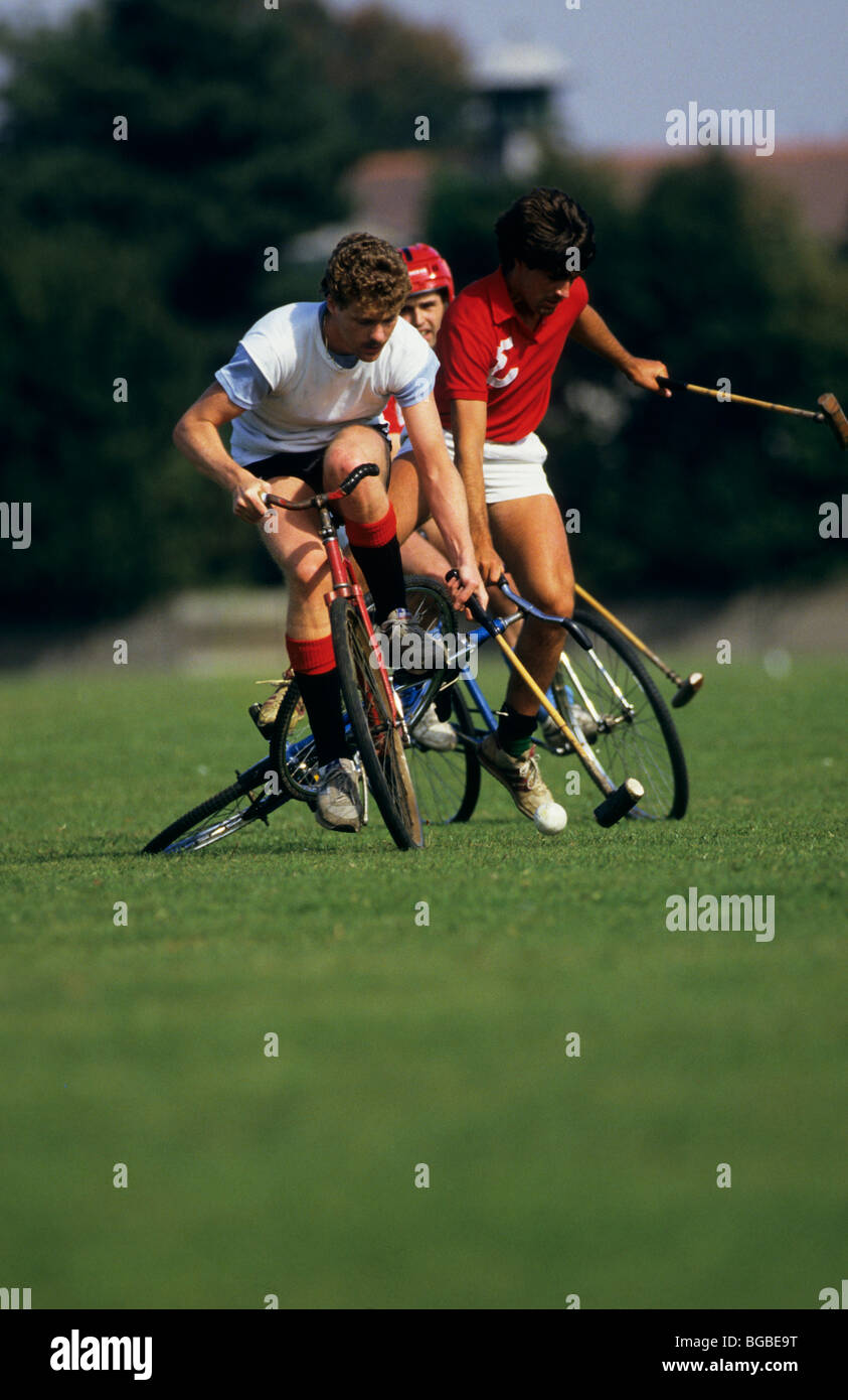 Three young men playing bicycle polo Stock Photo - Alamy