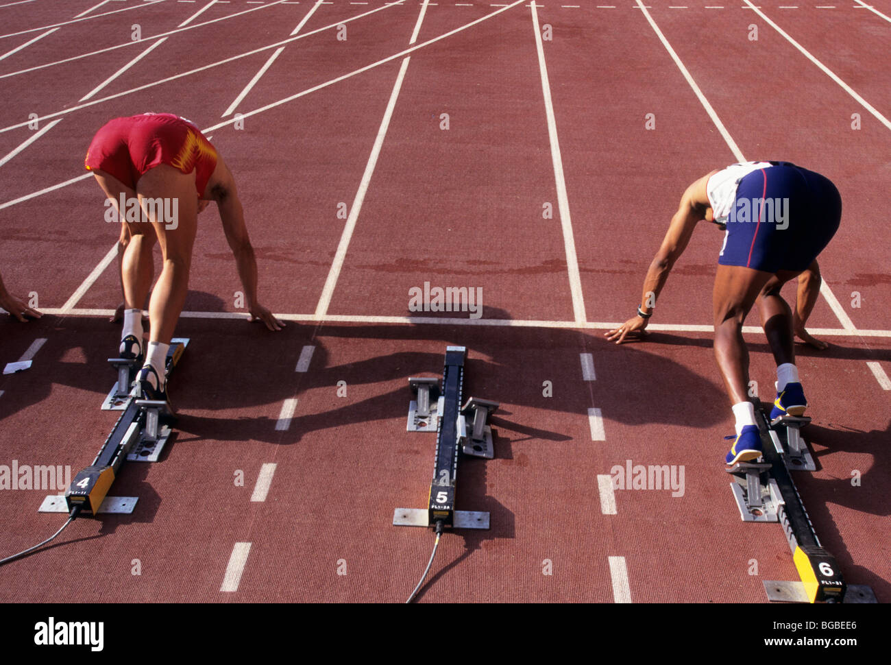 Two sprinters in their starting blocks Stock Photo - Alamy