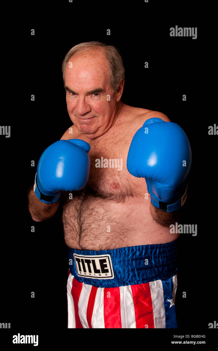 frontal shot on black background of aging man in american flag boxer ...