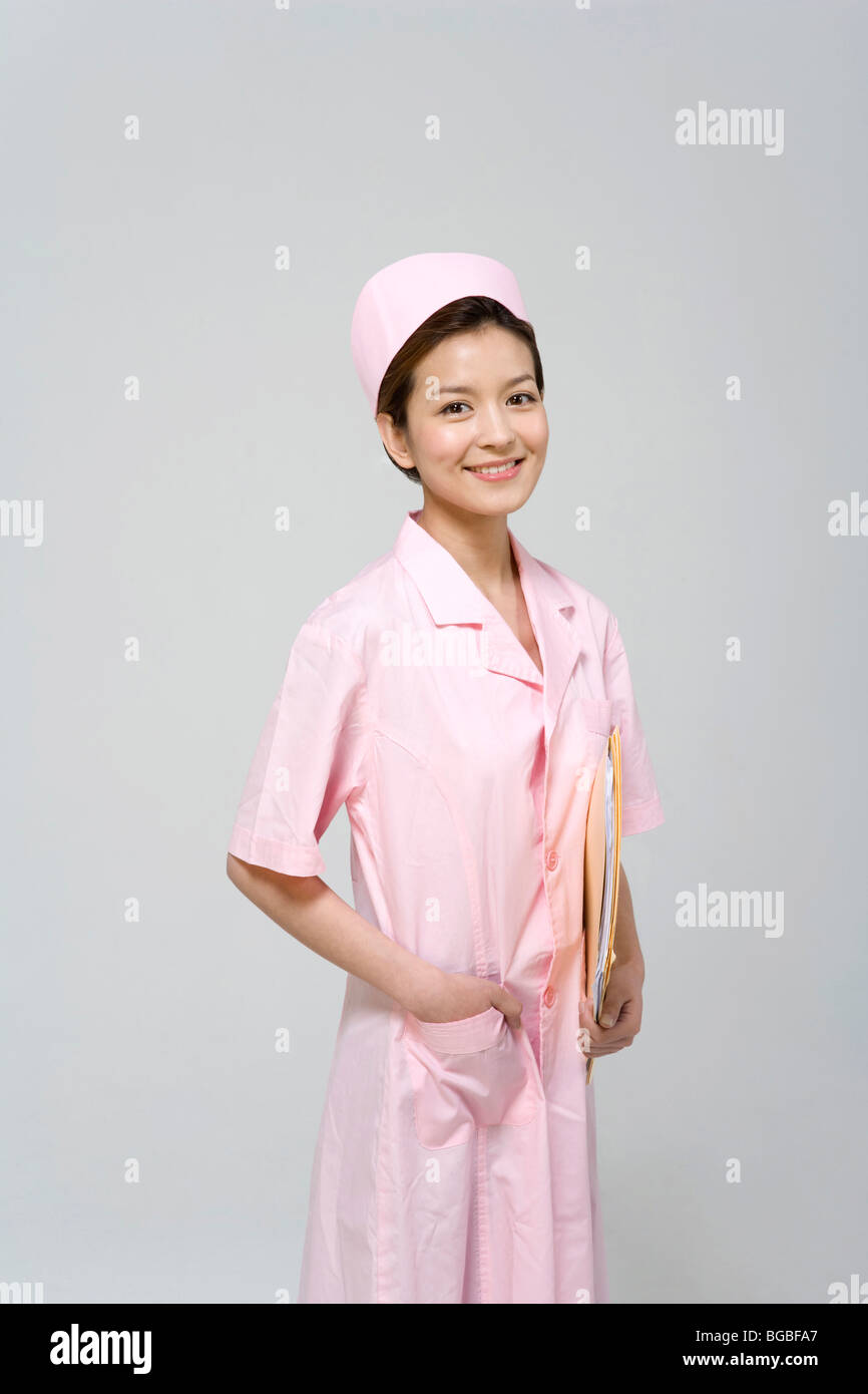 Nurse in pink uniform Stock Photo - Alamy