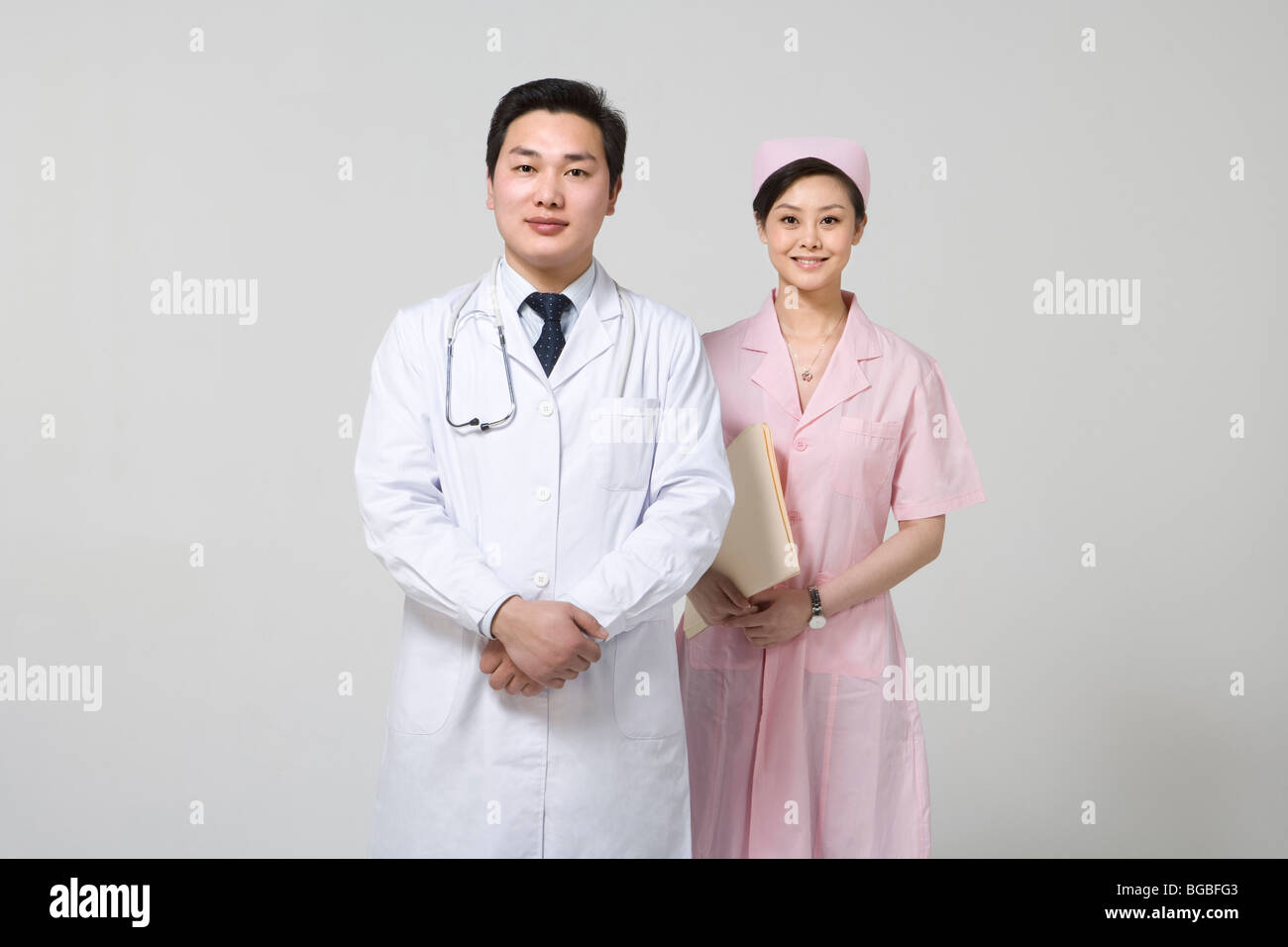 Doctor with nurse in pink uniform Stock Photo - Alamy
