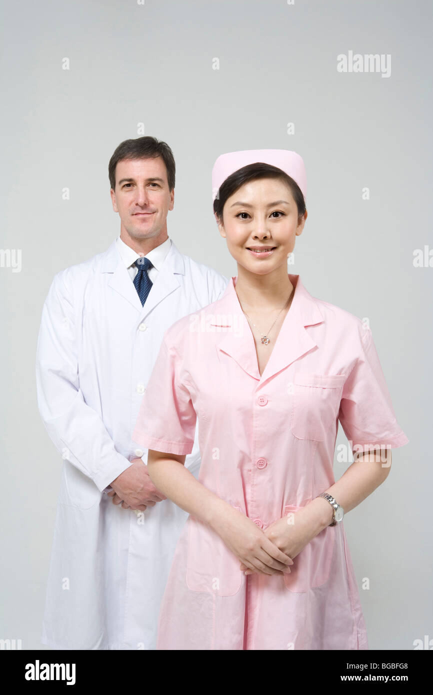 Doctor with nurse in pink uniform Stock Photo - Alamy
