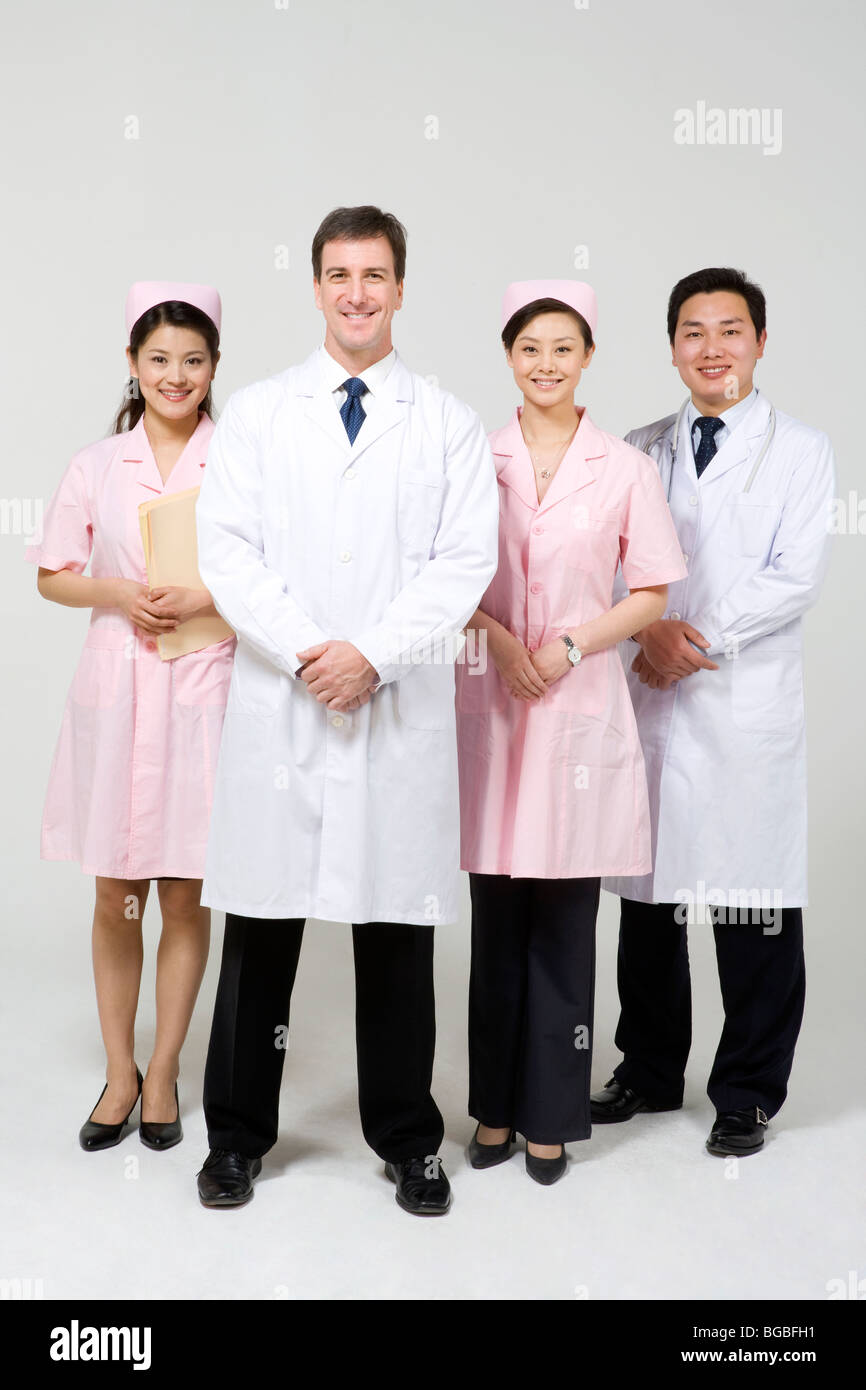 Doctors with nurses in pink uniforms Stock Photo - Alamy