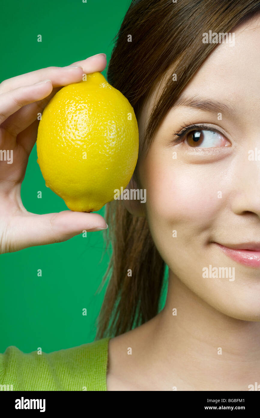 Woman in green with a lemon Stock Photo - Alamy
