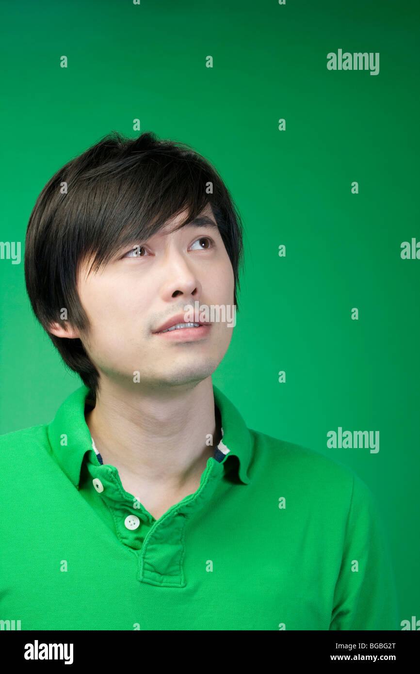 Man in green on green background Stock Photo - Alamy