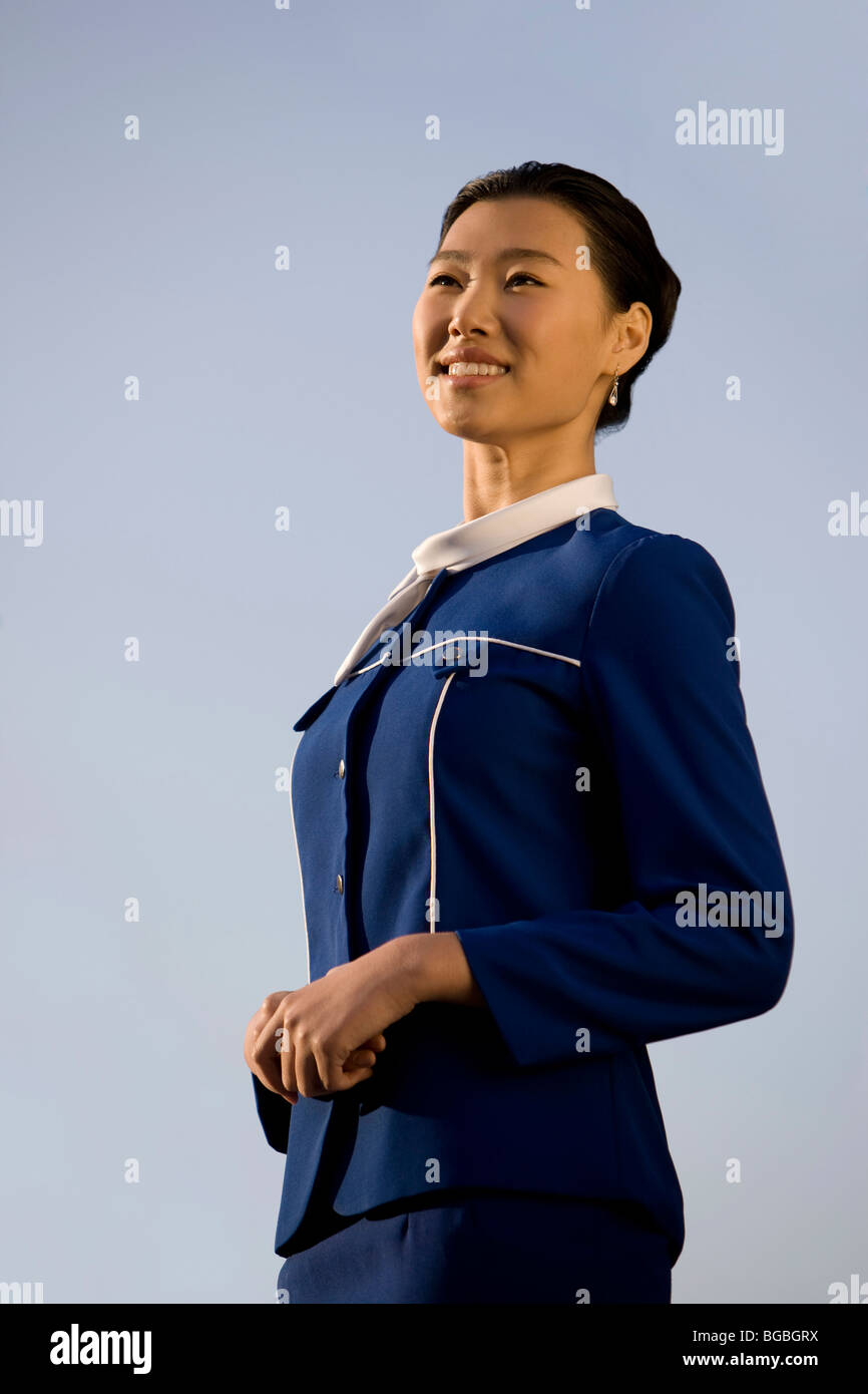 Smiling Flight Attendant Stock Photo - Alamy