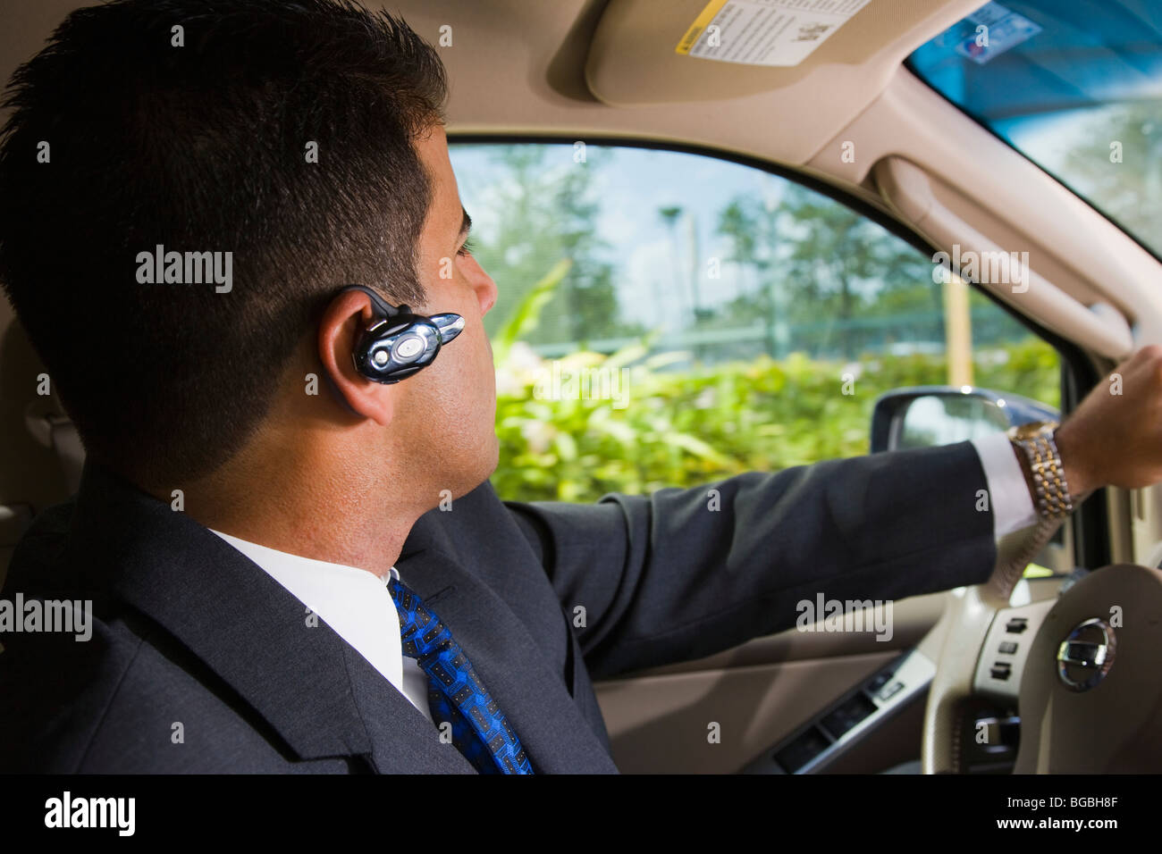 Businessman driving with hands-free device, close up Stock Photo - Alamy