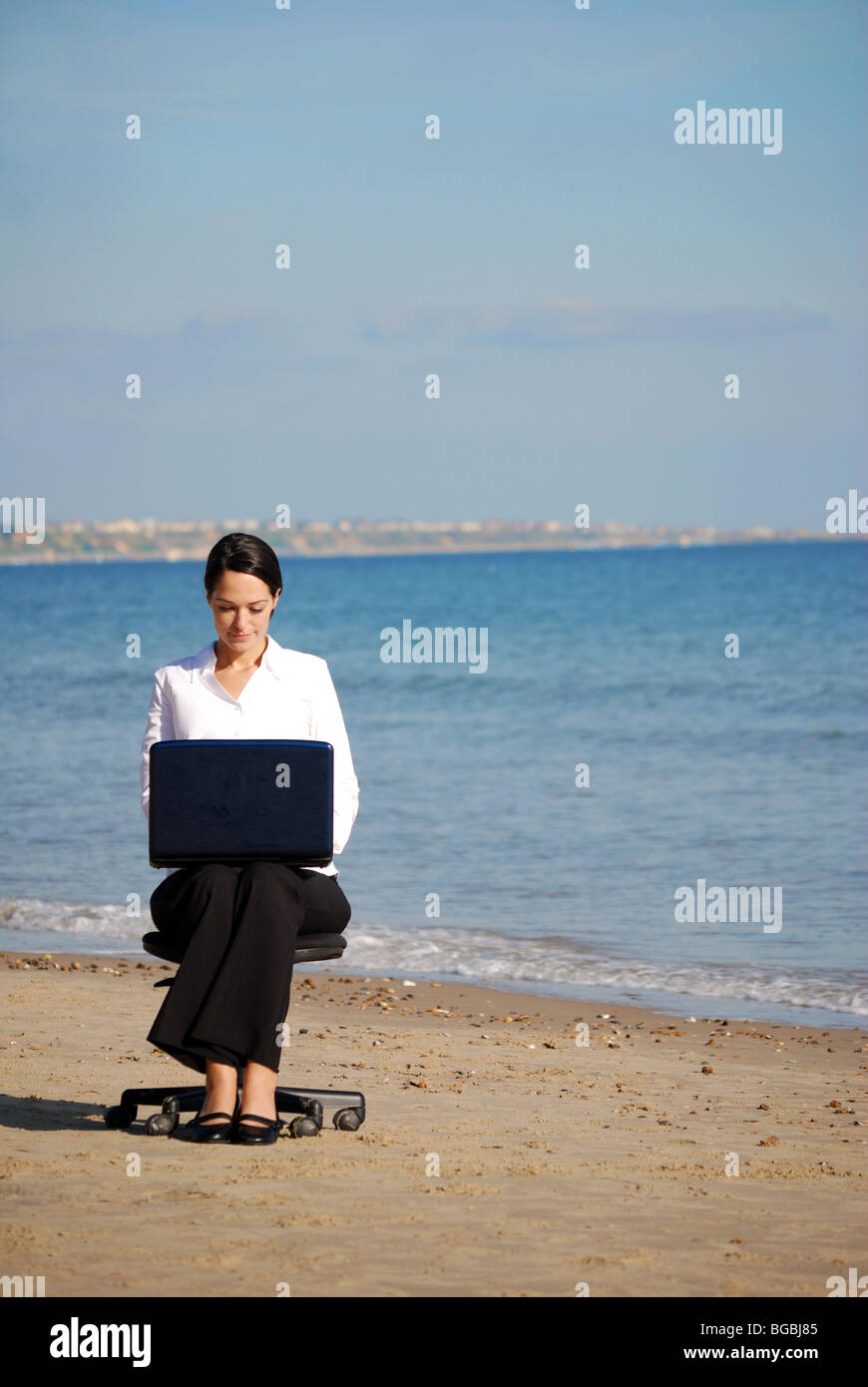 Young female office worker on the beach Stock Photo - Alamy