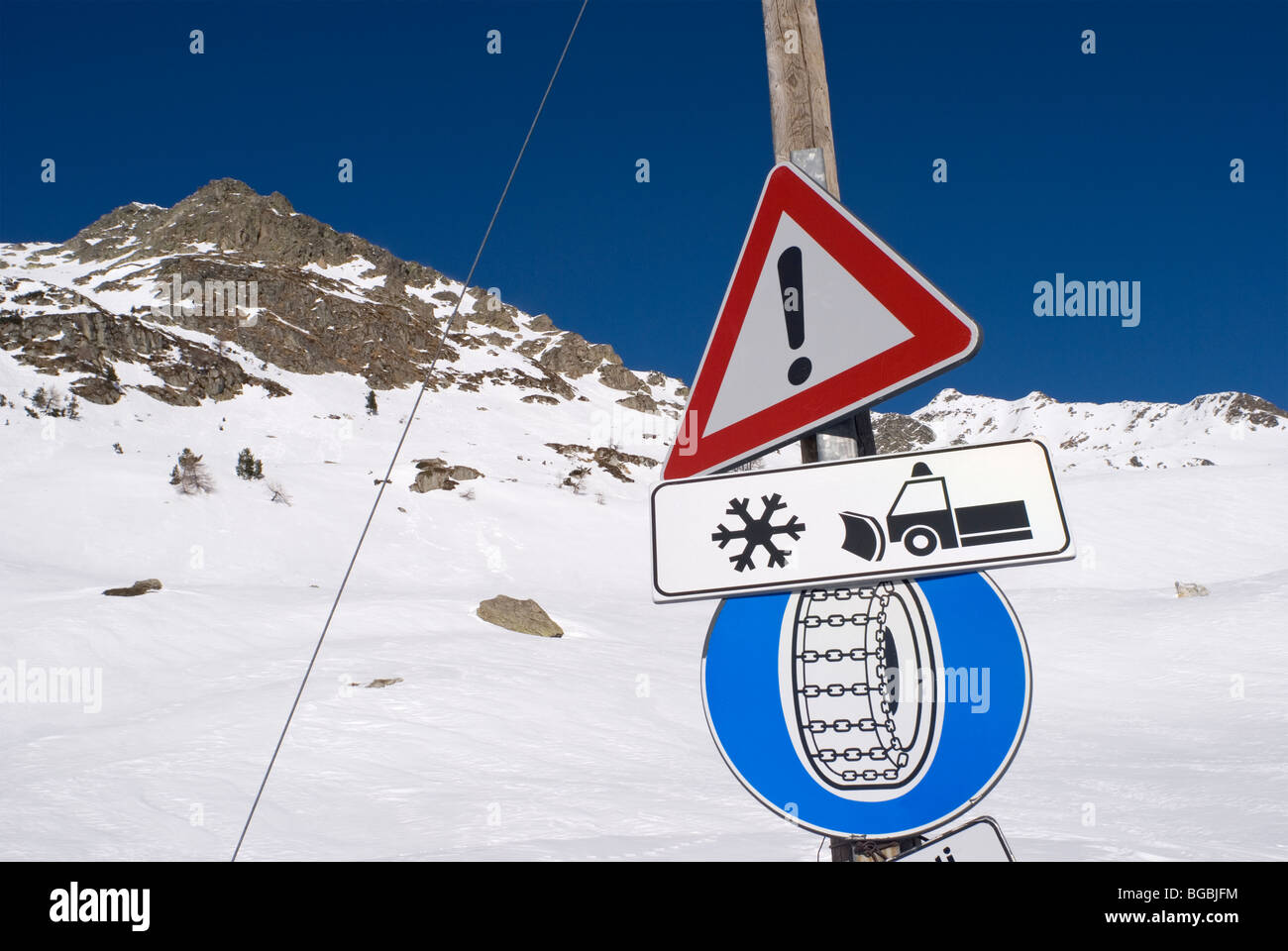 warning road signs on pole during the winter - Italian Alps Stock Photo ...