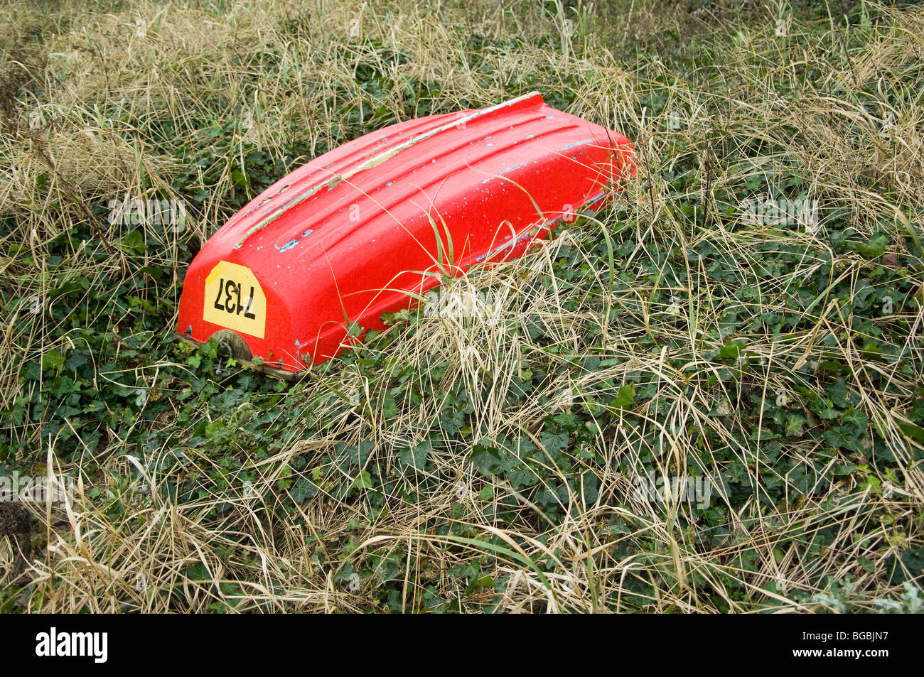 A discarded red dingy Stock Photo - Alamy