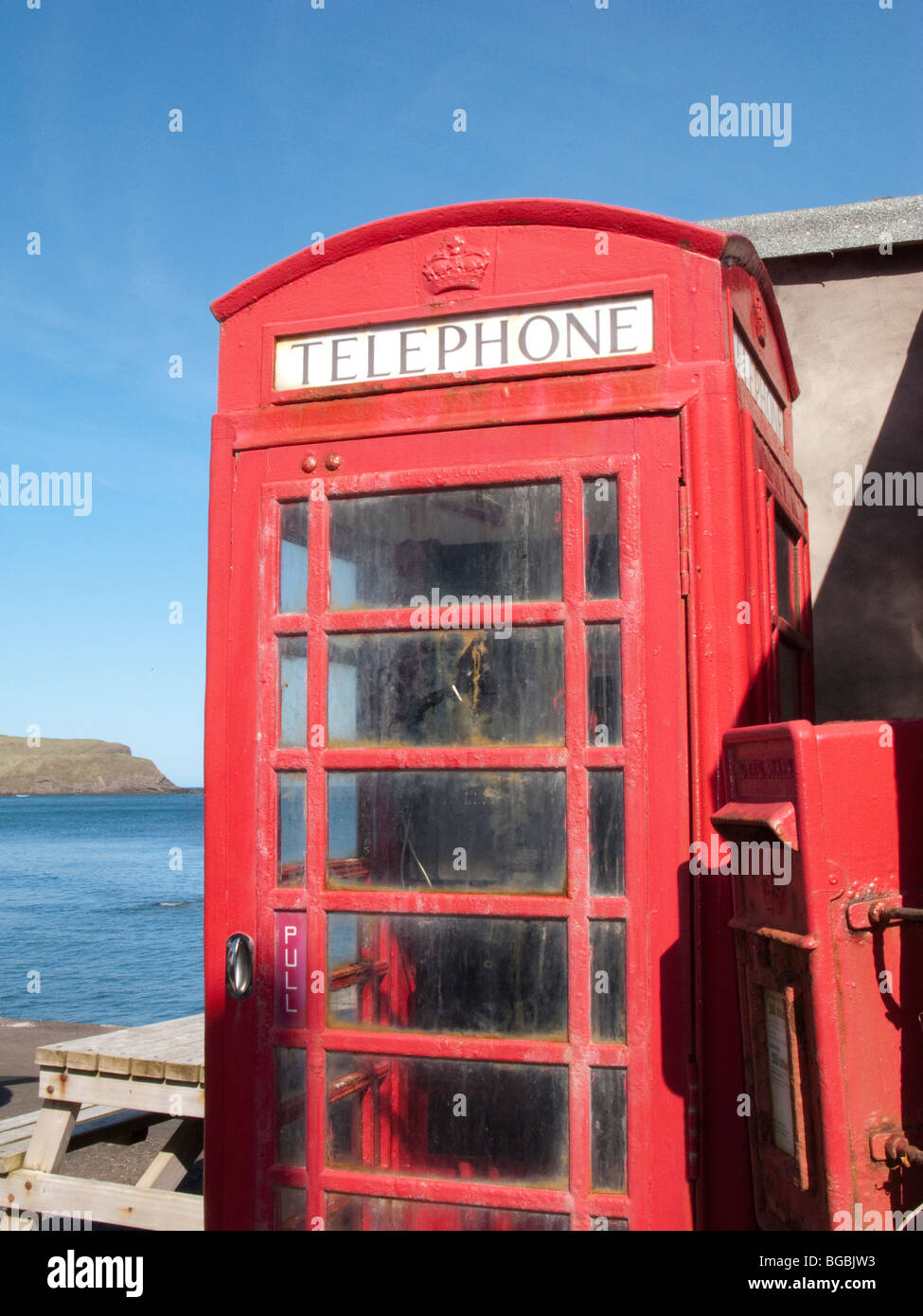 Old fashioned red telephone box and post box at sea front in Pennan ...