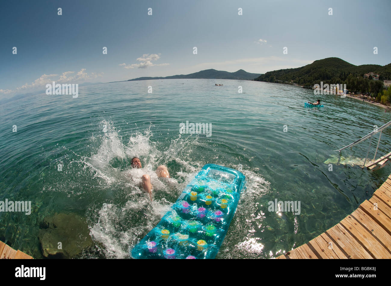 Man Falling off lilo Into Sea. Corfu, Greece Stock Photo - Alamy