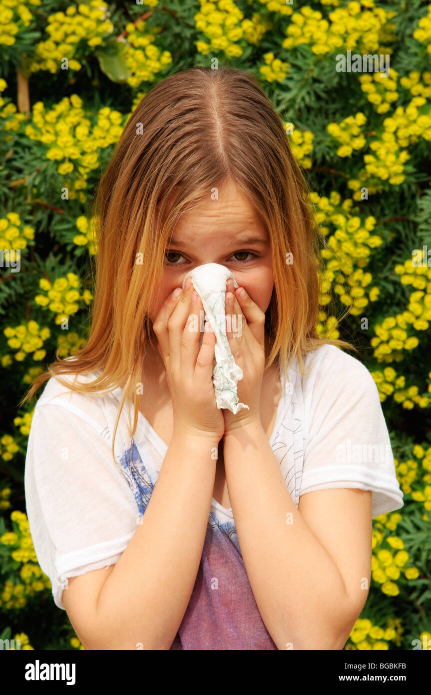 Girl blowing her nose Stock Photo - Alamy