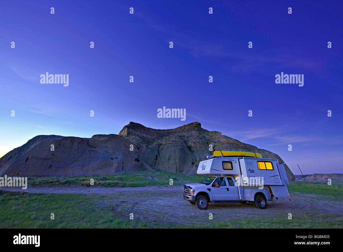 Camper at Castle Butte at dusk in the Big Muddy Badlands of Southern ...