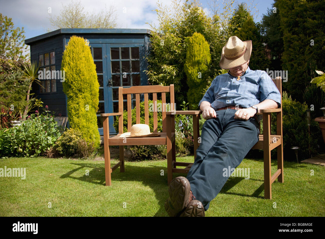 Man asleep outside chair hi-res stock photography and images - Alamy
