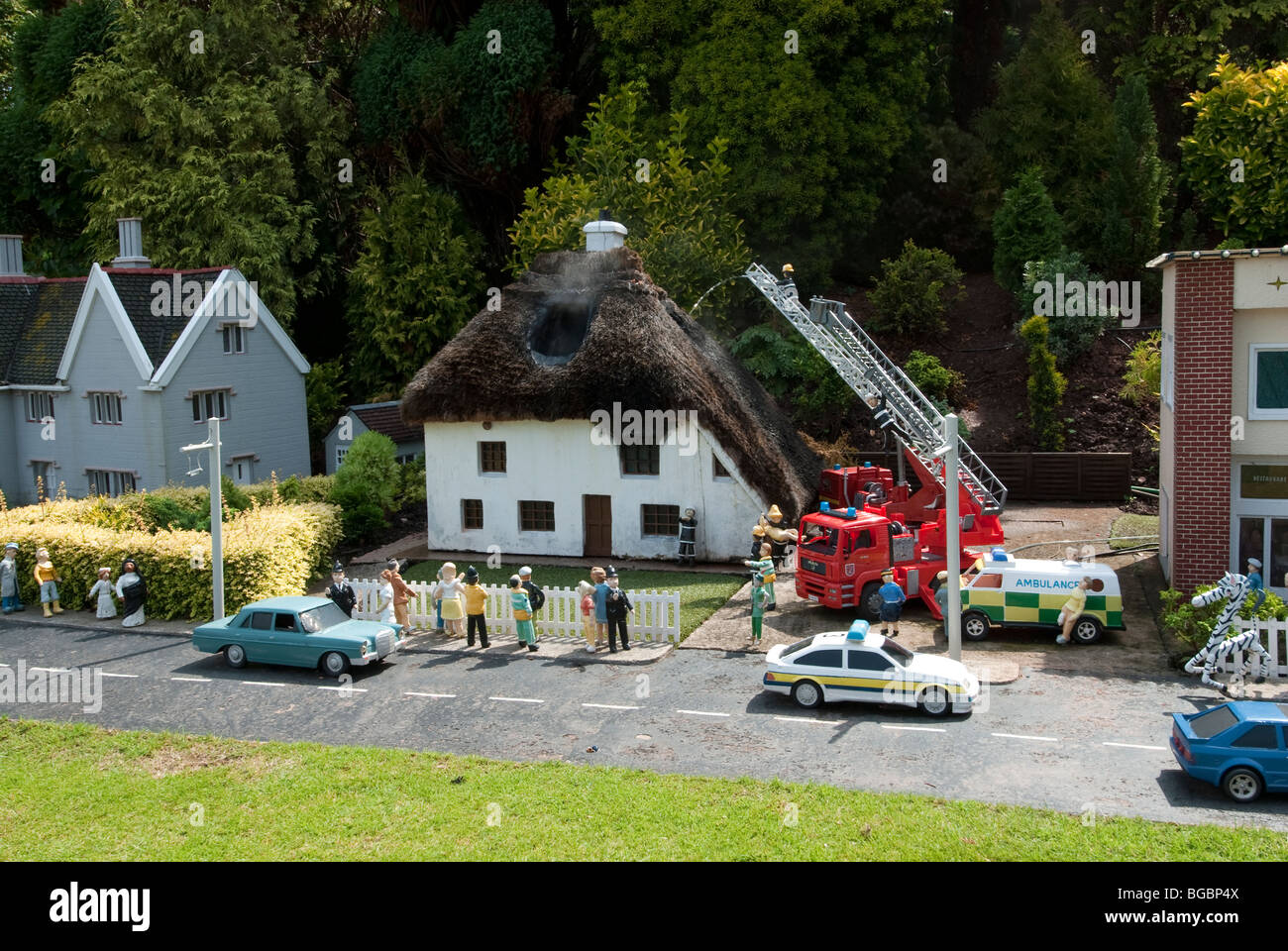 Model of thatched cottage with fire engine and police Stock Photo - Alamy