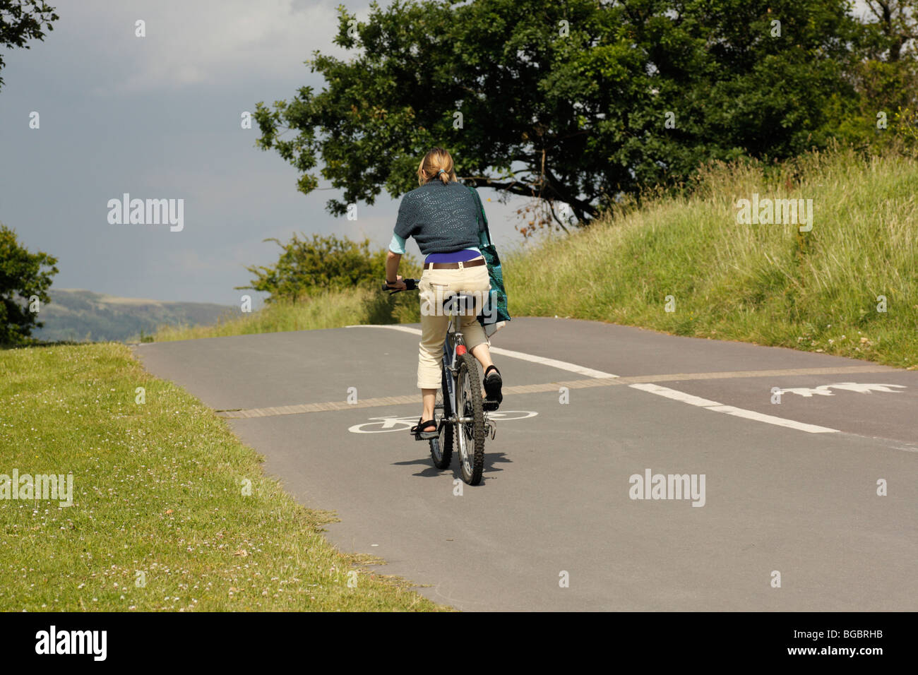 Young Woman Riding a Bicycle along a Cycle Path Stock Photo - Alamy