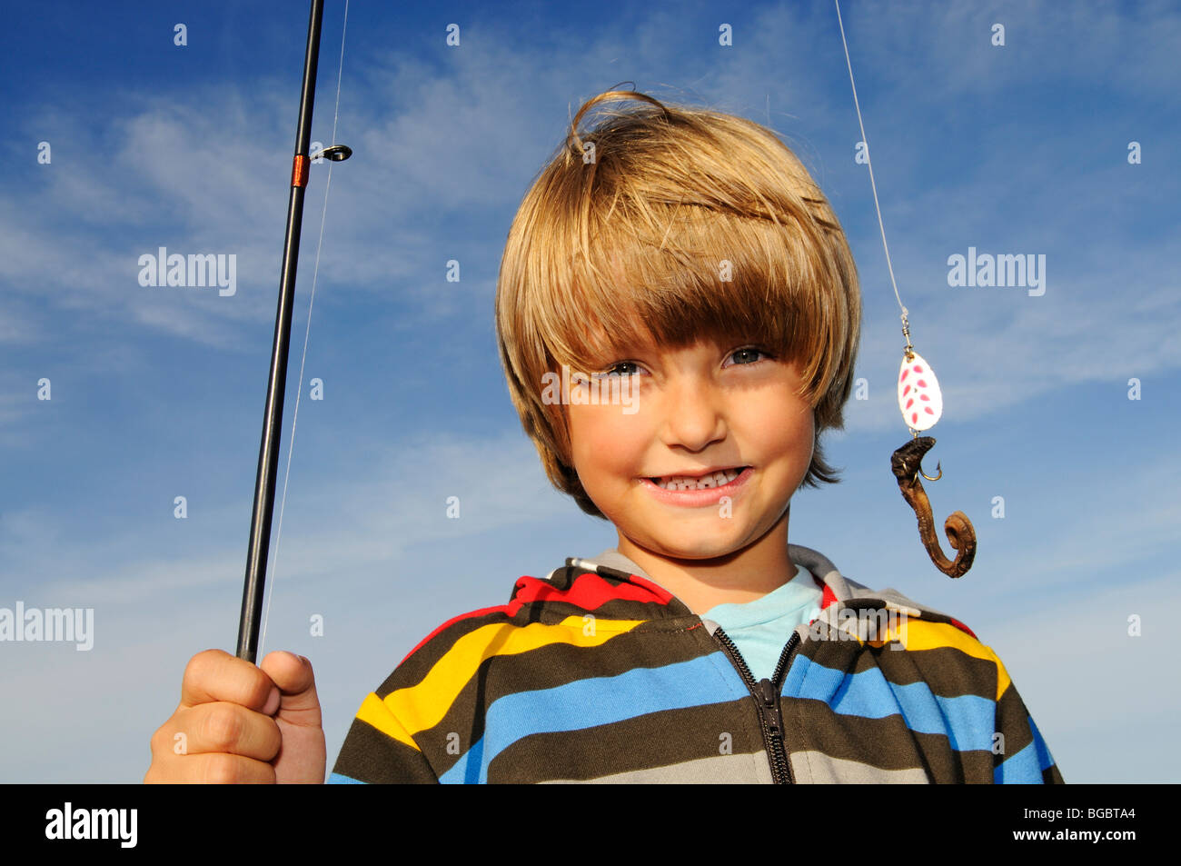 Boy with fishing rod and worm Stock Photo - Alamy