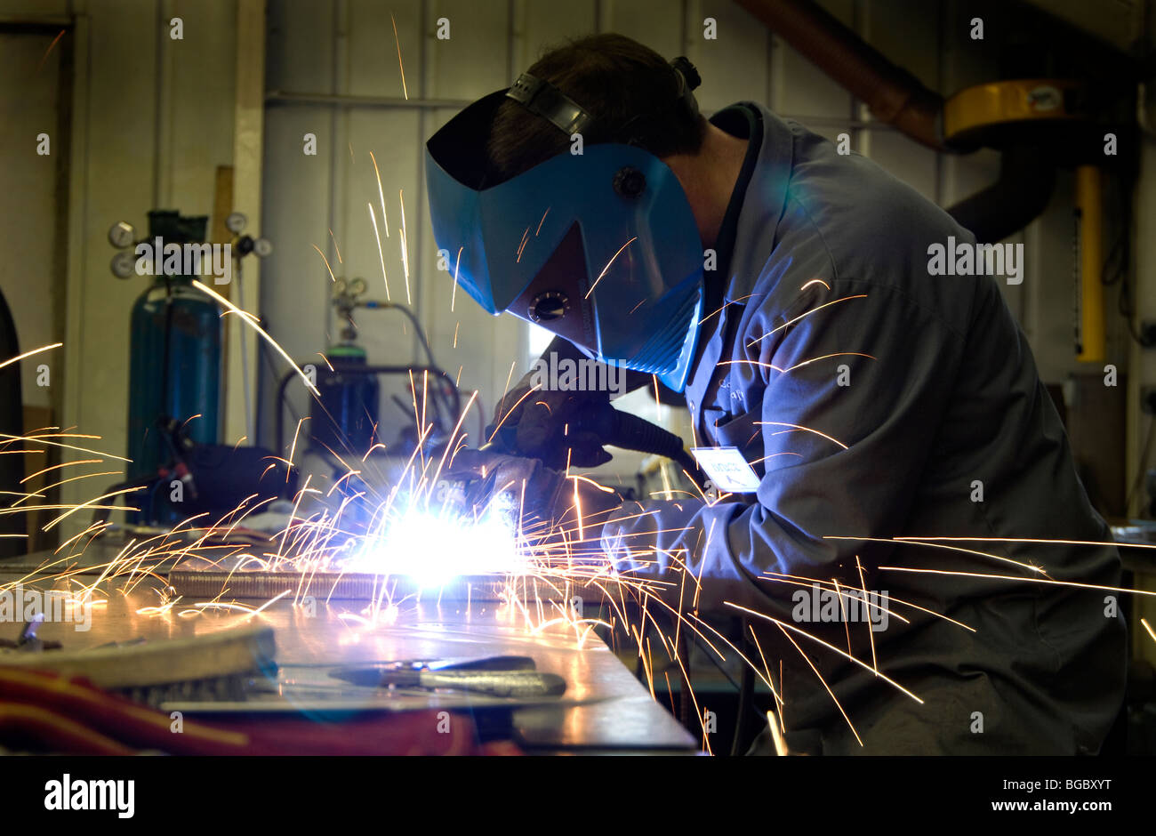 Welder at work with sparks flying Stock Photo - Alamy