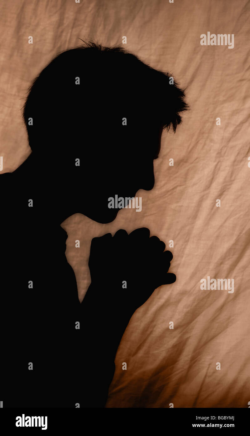 Shadow of man praying Stock Photo - Alamy