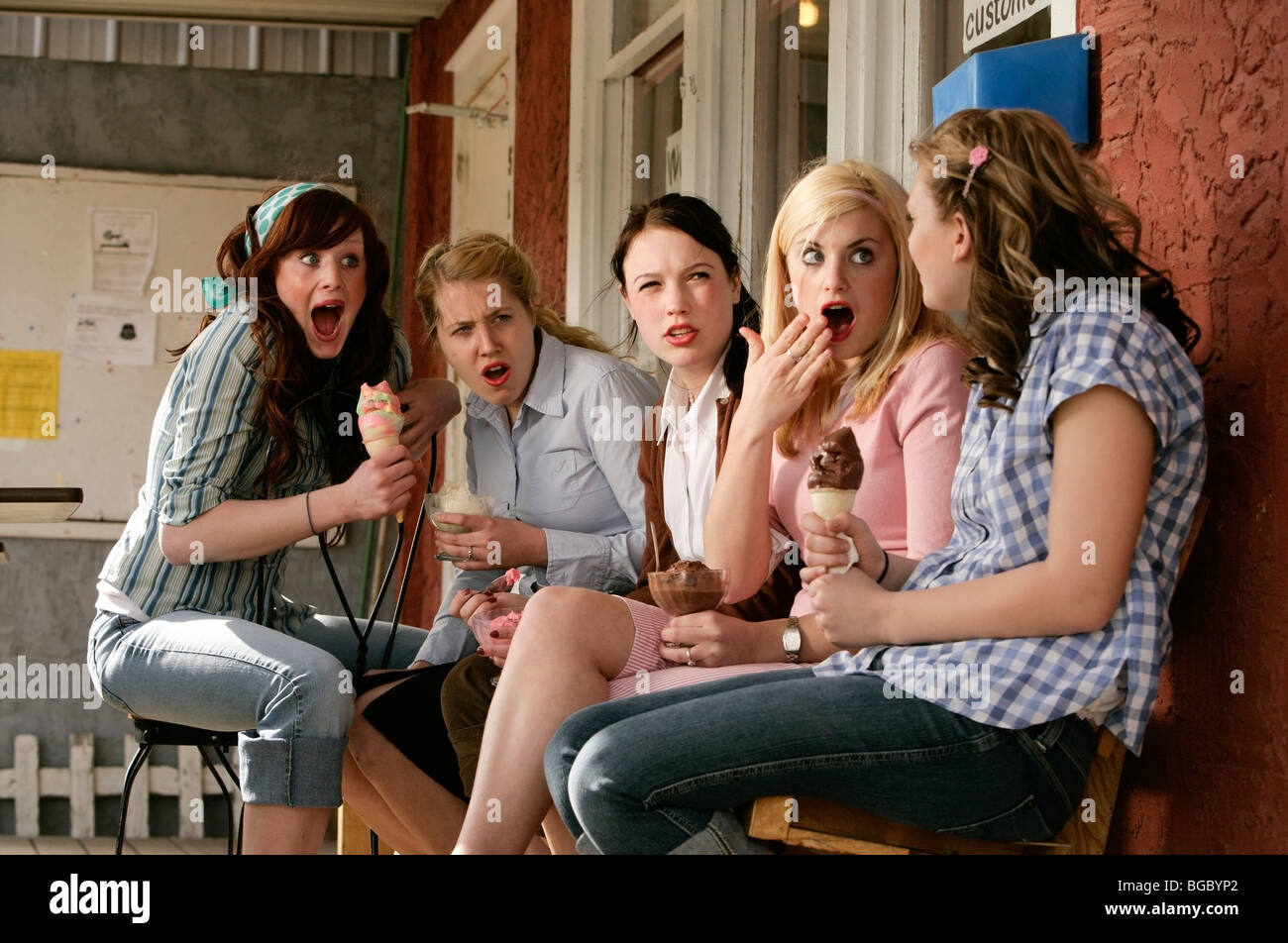 Girls sharing gossip Stock Photo - Alamy