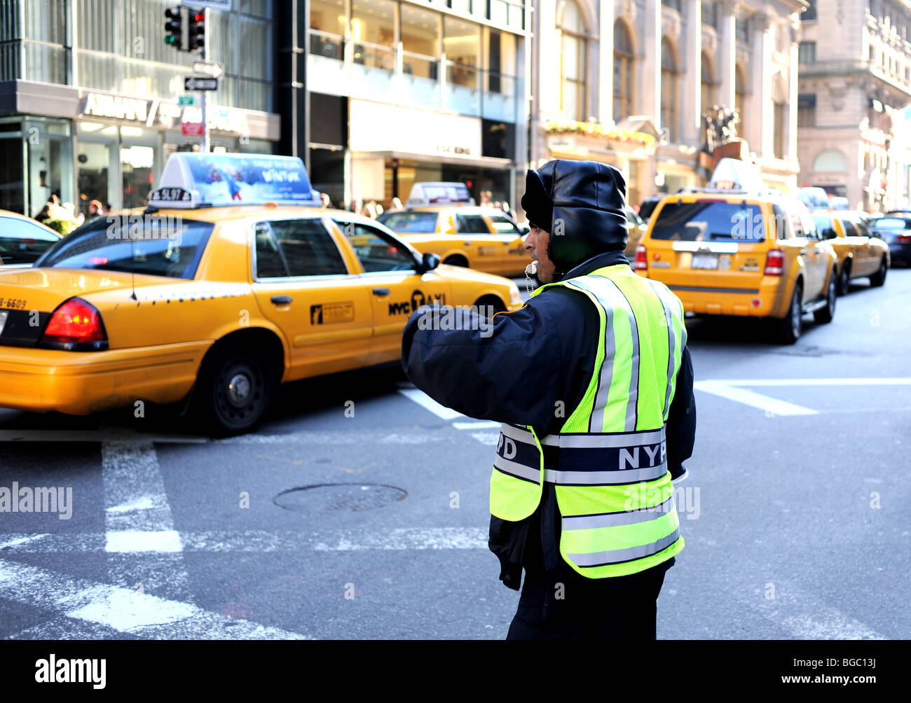 NYPD officer at work directing traffic Midtown Manhattan New York USA ...
