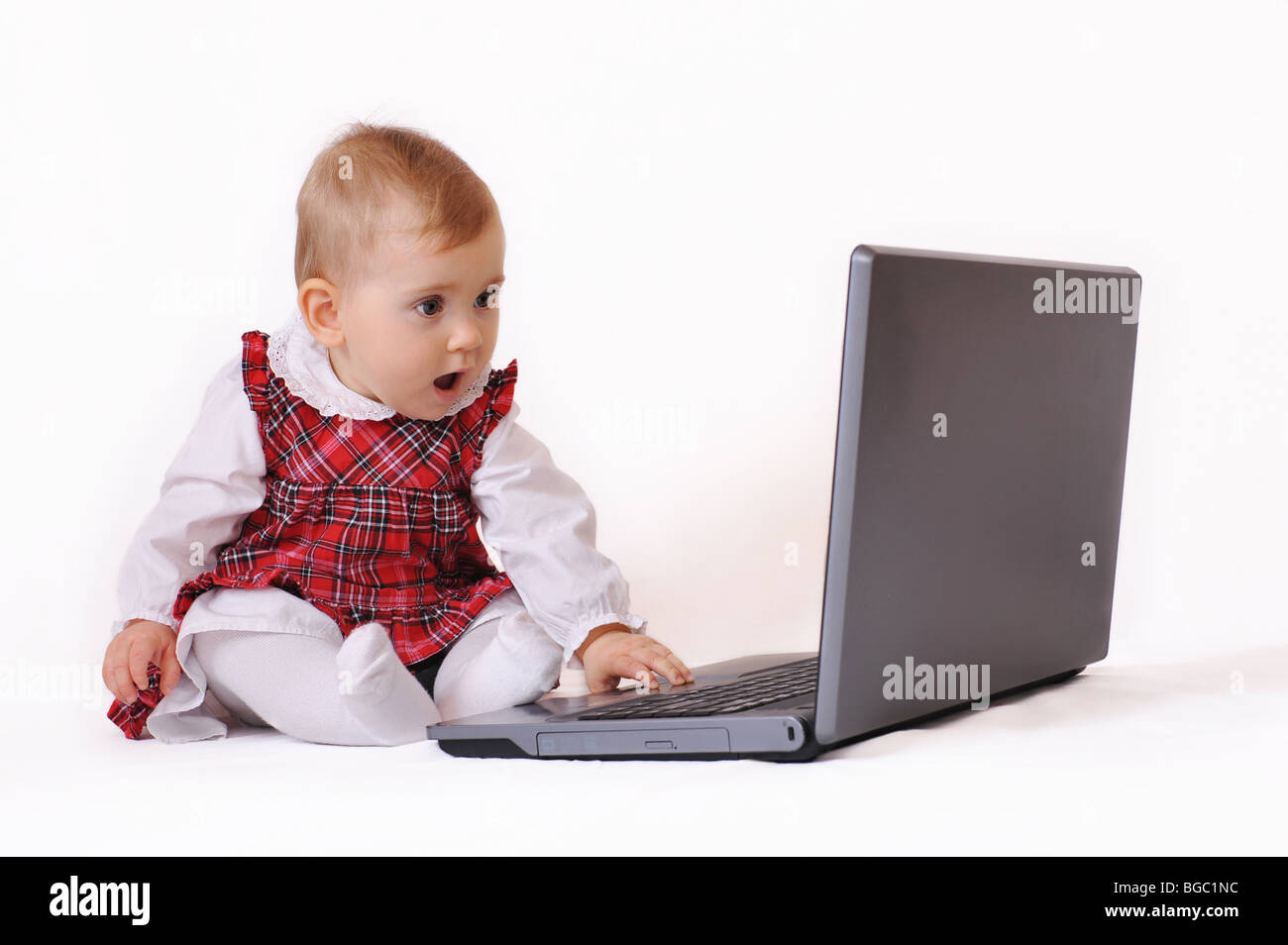Portrait of little baby working on computer Stock Photo - Alamy