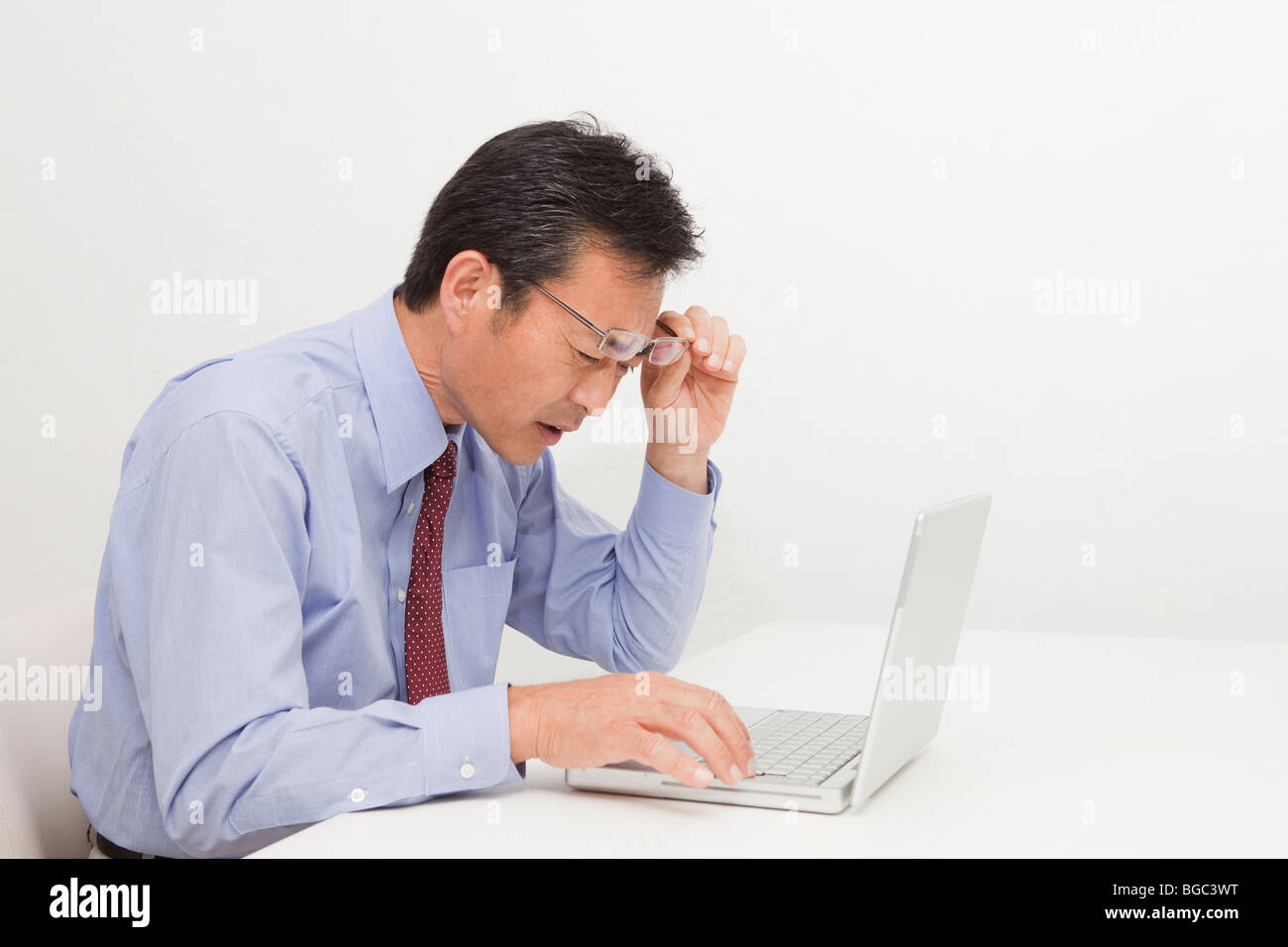 Mature man looking computer Stock Photo - Alamy