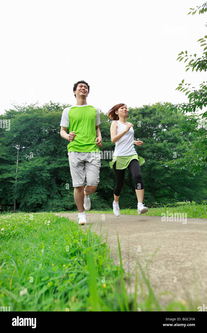 Young man and woman running Stock Photo - Alamy