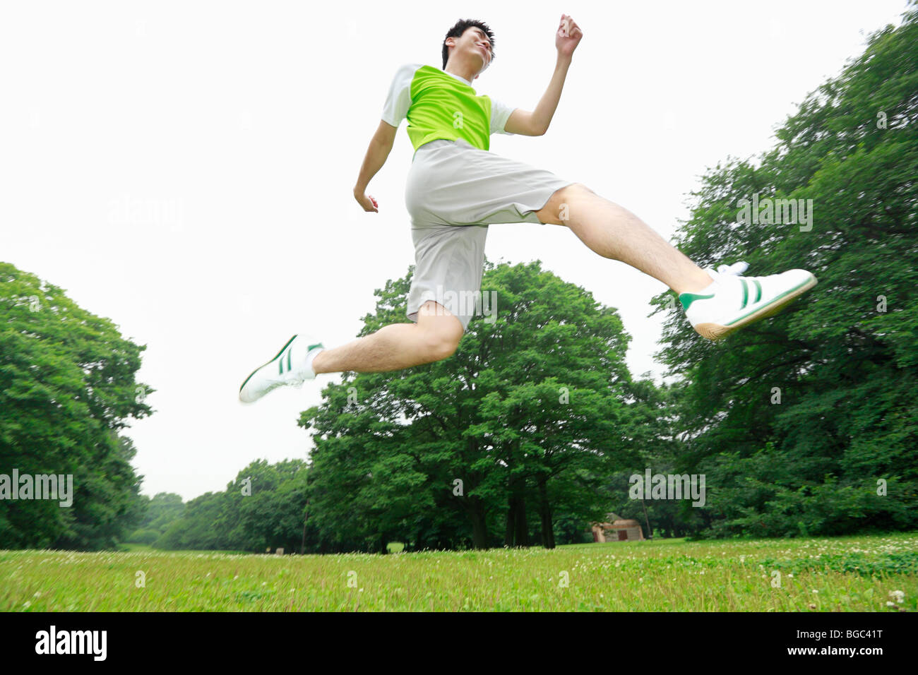 Young man jumping Stock Photo - Alamy