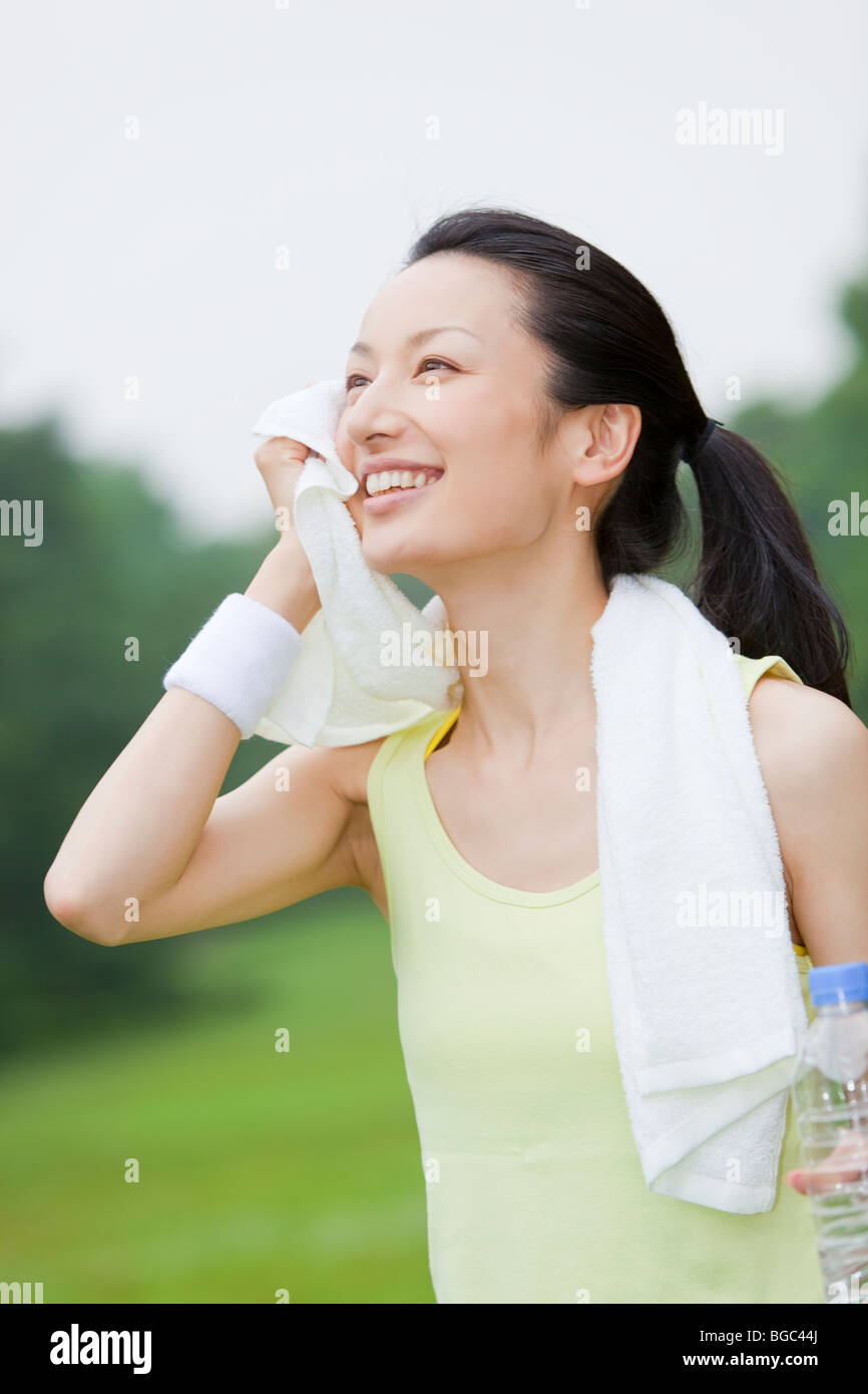 Mid adult woman wiping sweat Stock Photo - Alamy
