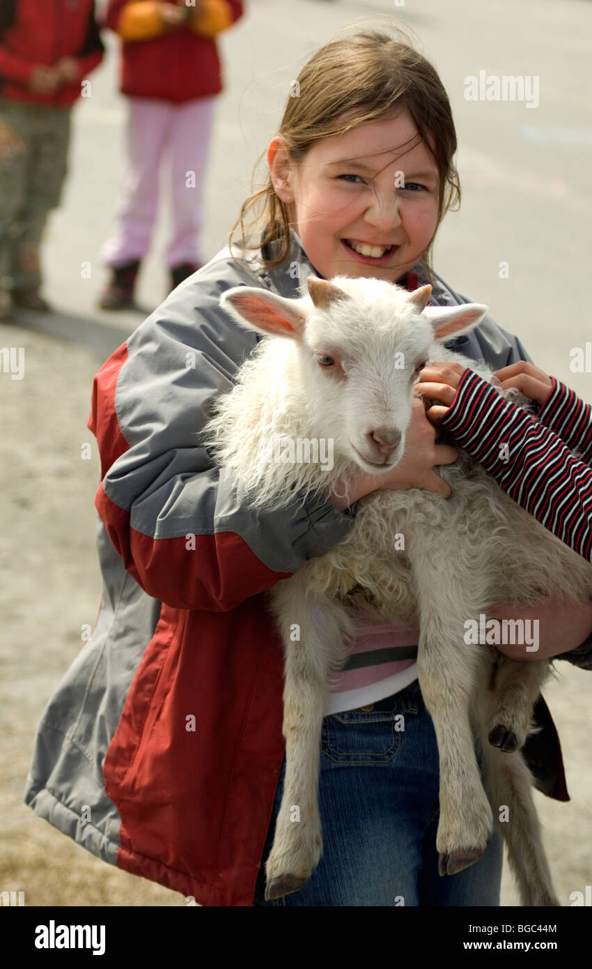 Young girl holding goat Stock Photo - Alamy