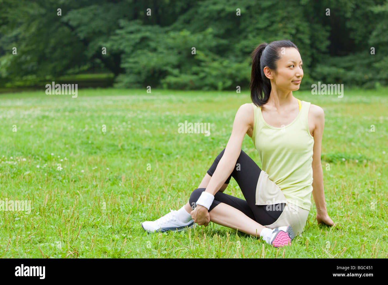 Mid adult woman stretching Stock Photo - Alamy