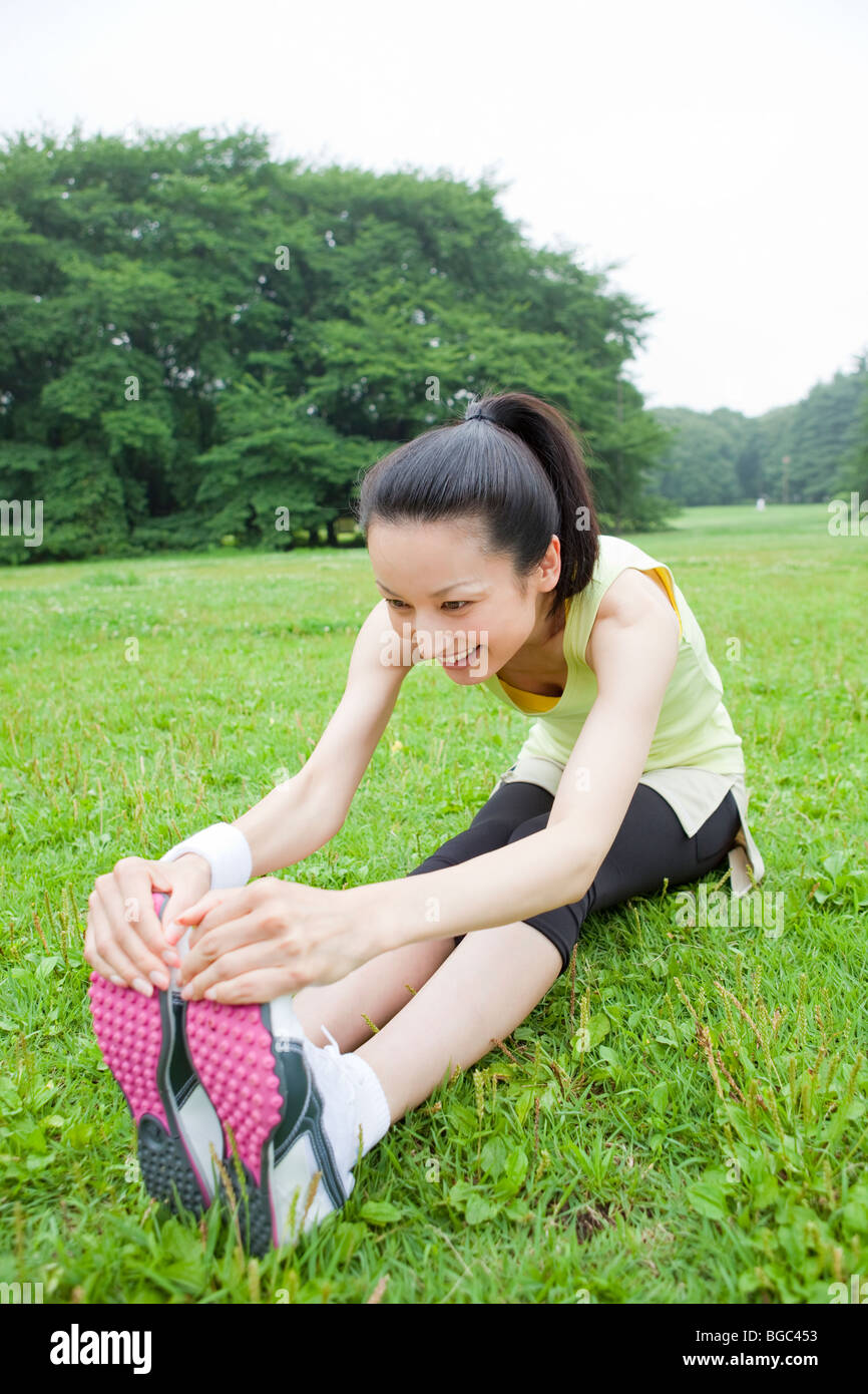 Mid adult woman stretching Stock Photo - Alamy