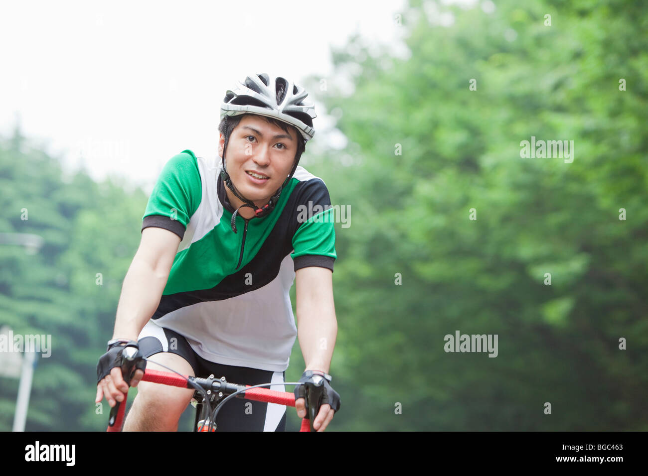 Young man riding bicycle Stock Photo - Alamy