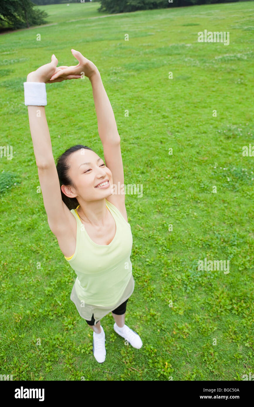 Mid adult woman stretching Stock Photo - Alamy