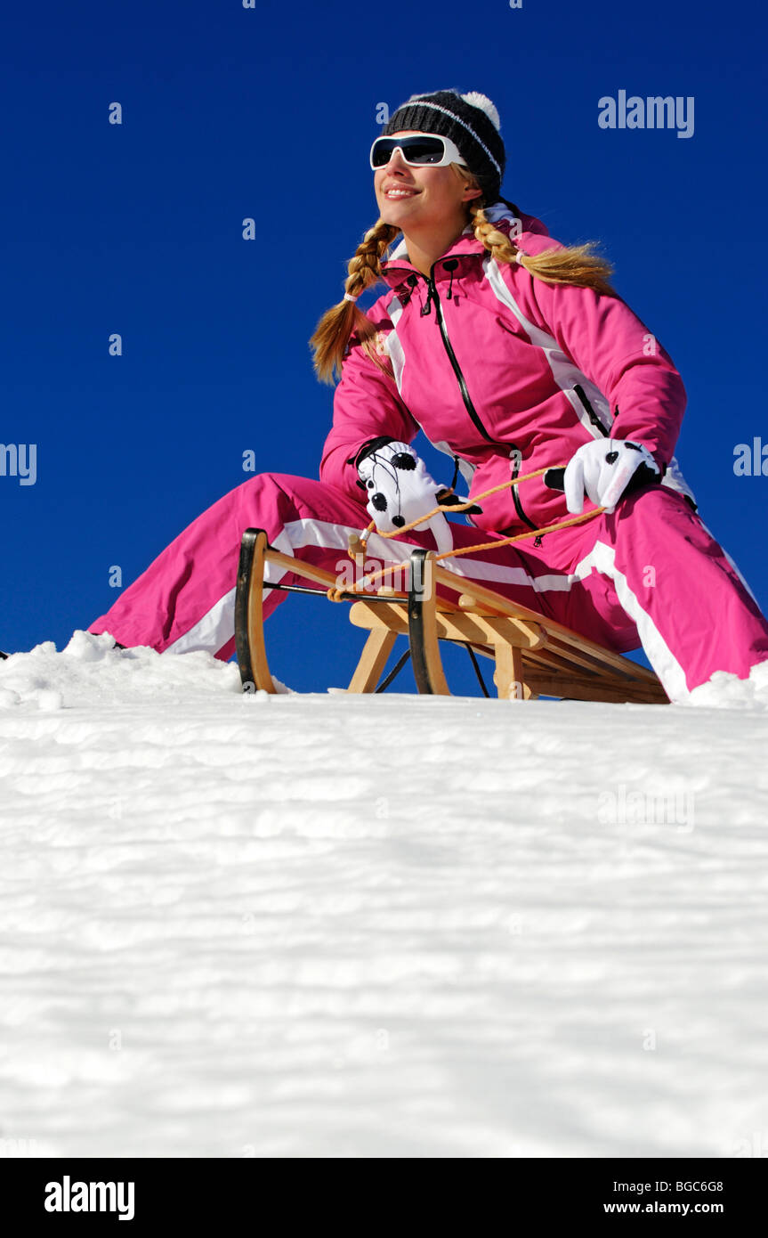 Woman on sled Stock Photo - Alamy