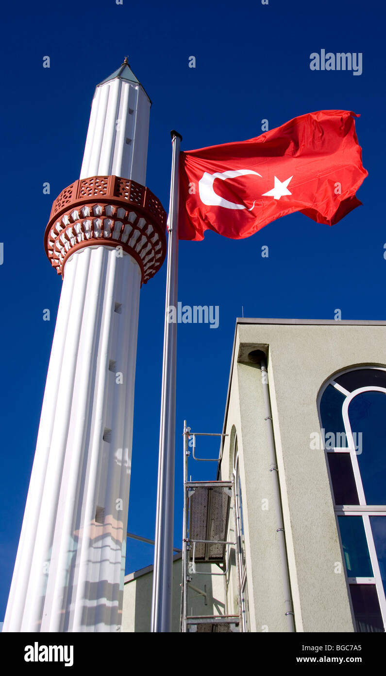 Flag of Turkey and the minaret of the Tuerkiyem Mevlana mosque ...
