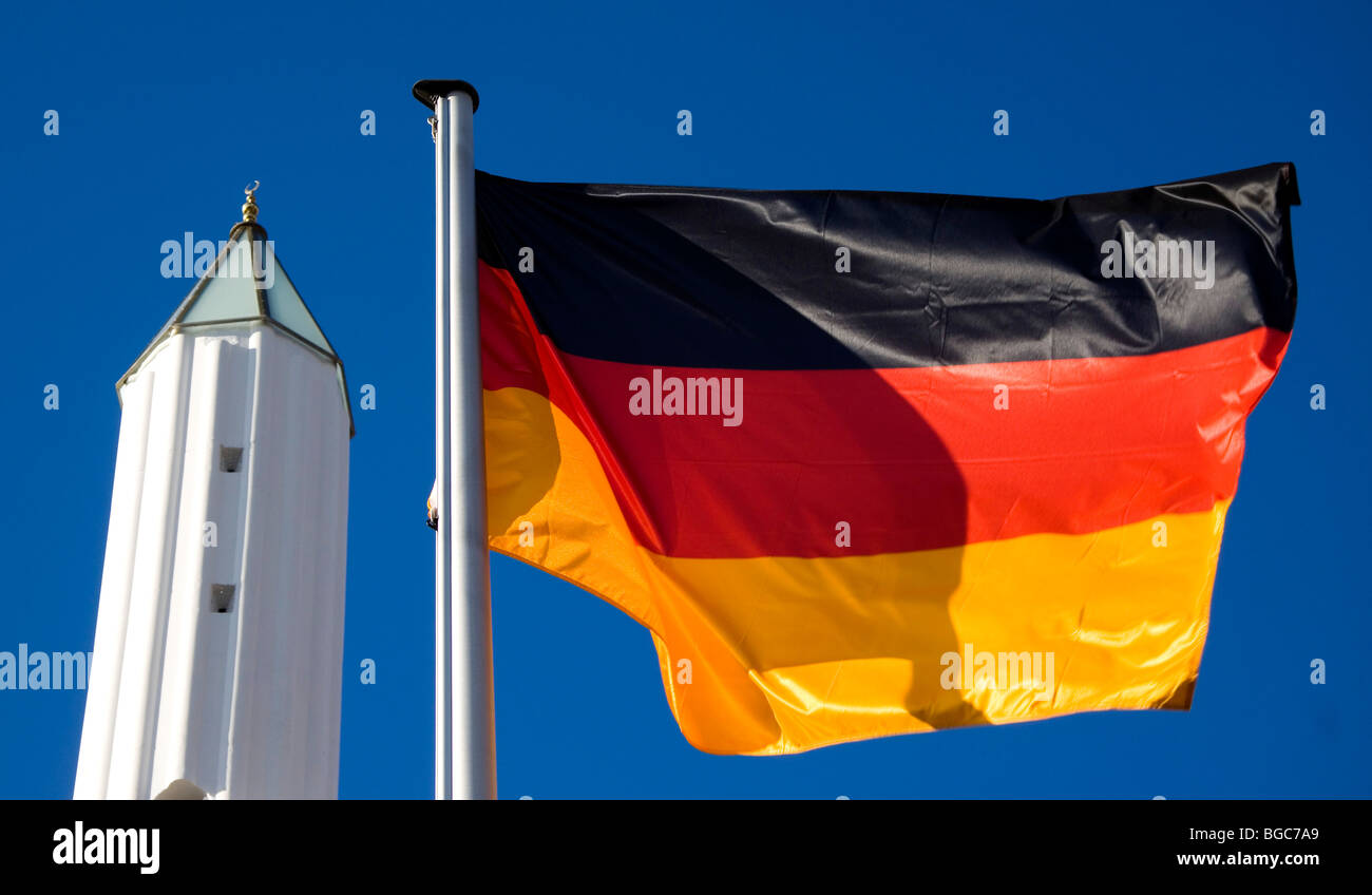 Flag of Germany and the minaret of the Tuerkiyem Mevlana mosque ...